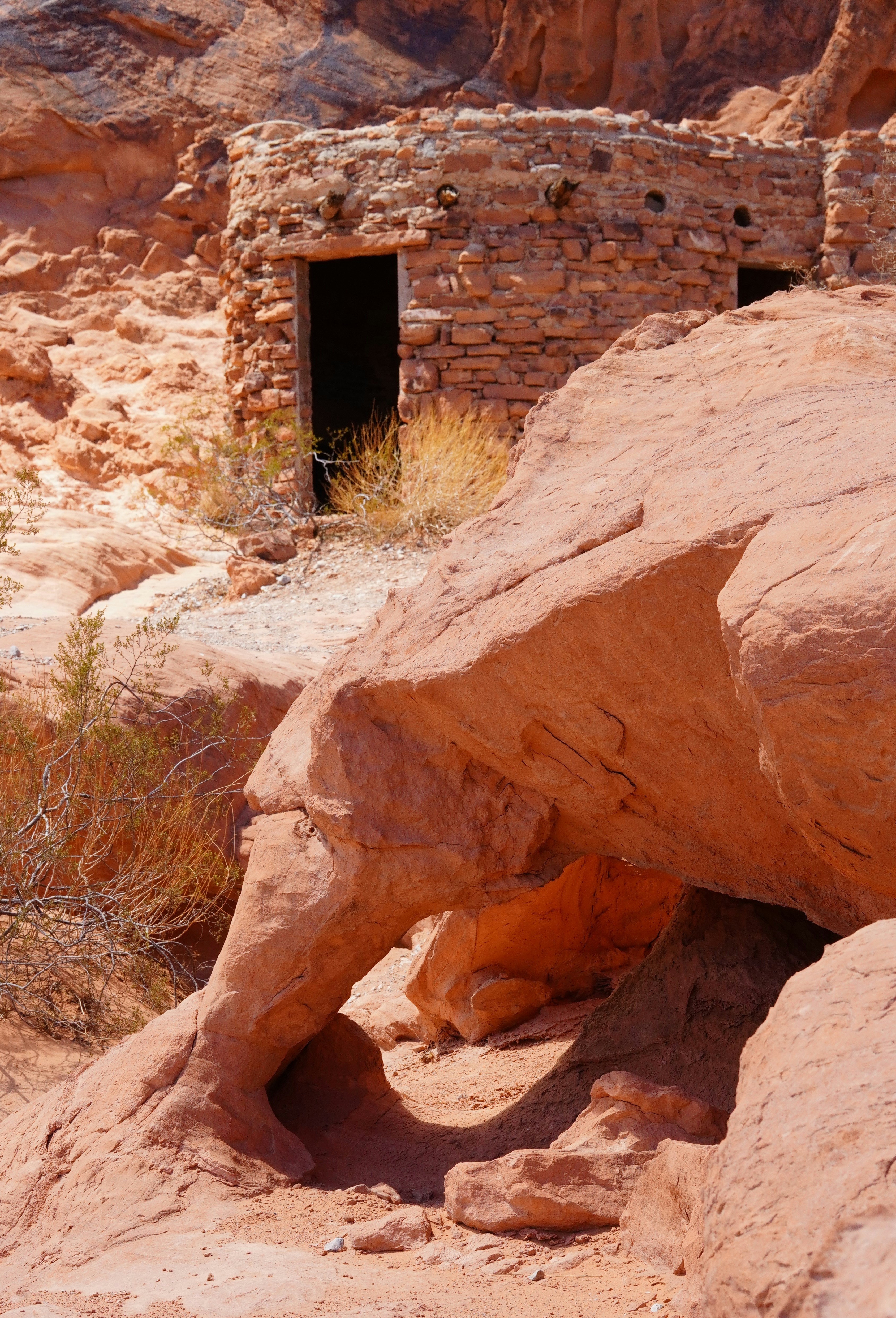 Desert Ruins: An Abandoned Brick Shelter Reclines Among Red Rocks