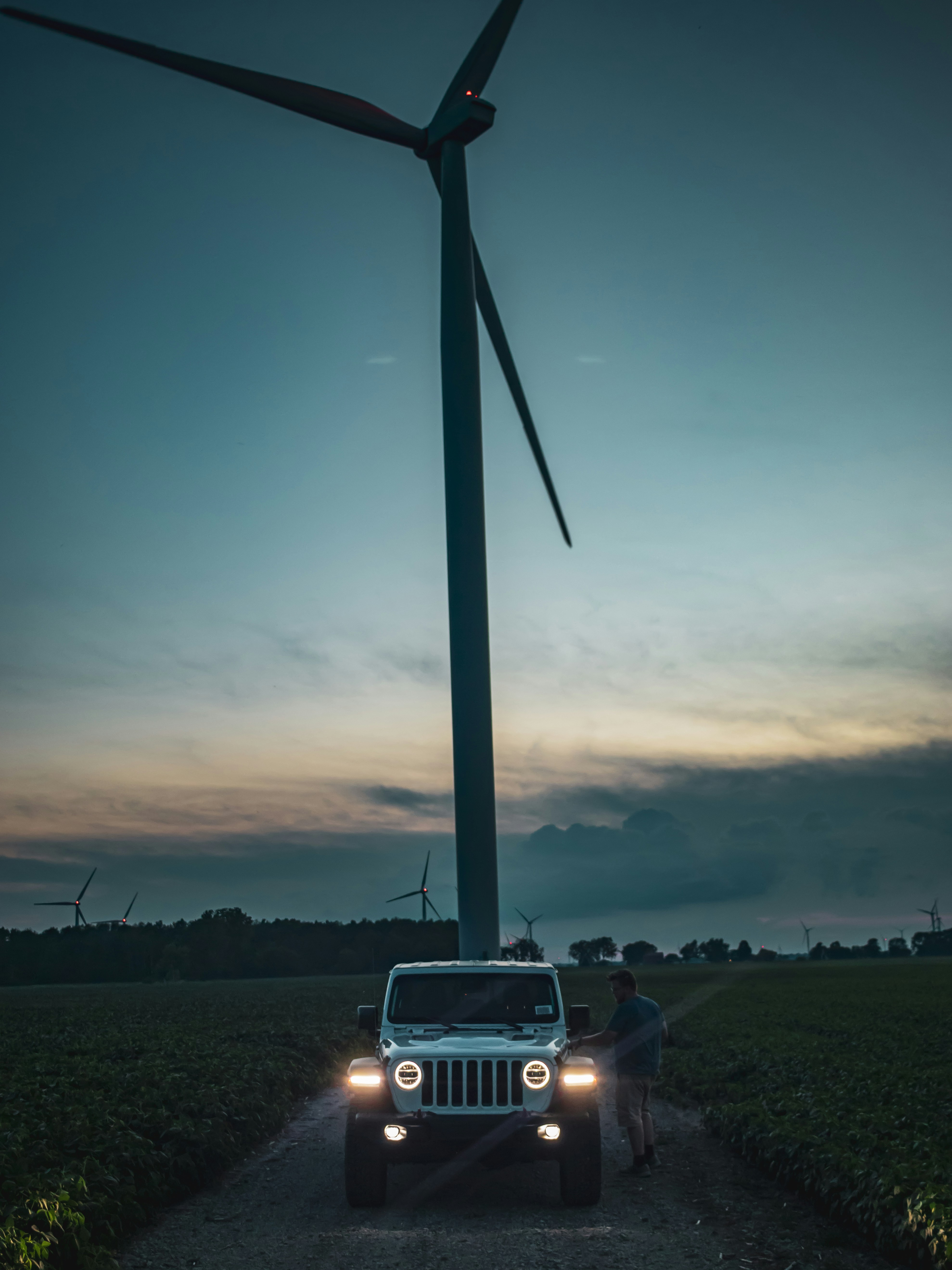 Blue Hour Sentinel: A Wind Turbine Over a Quiet Farm Road