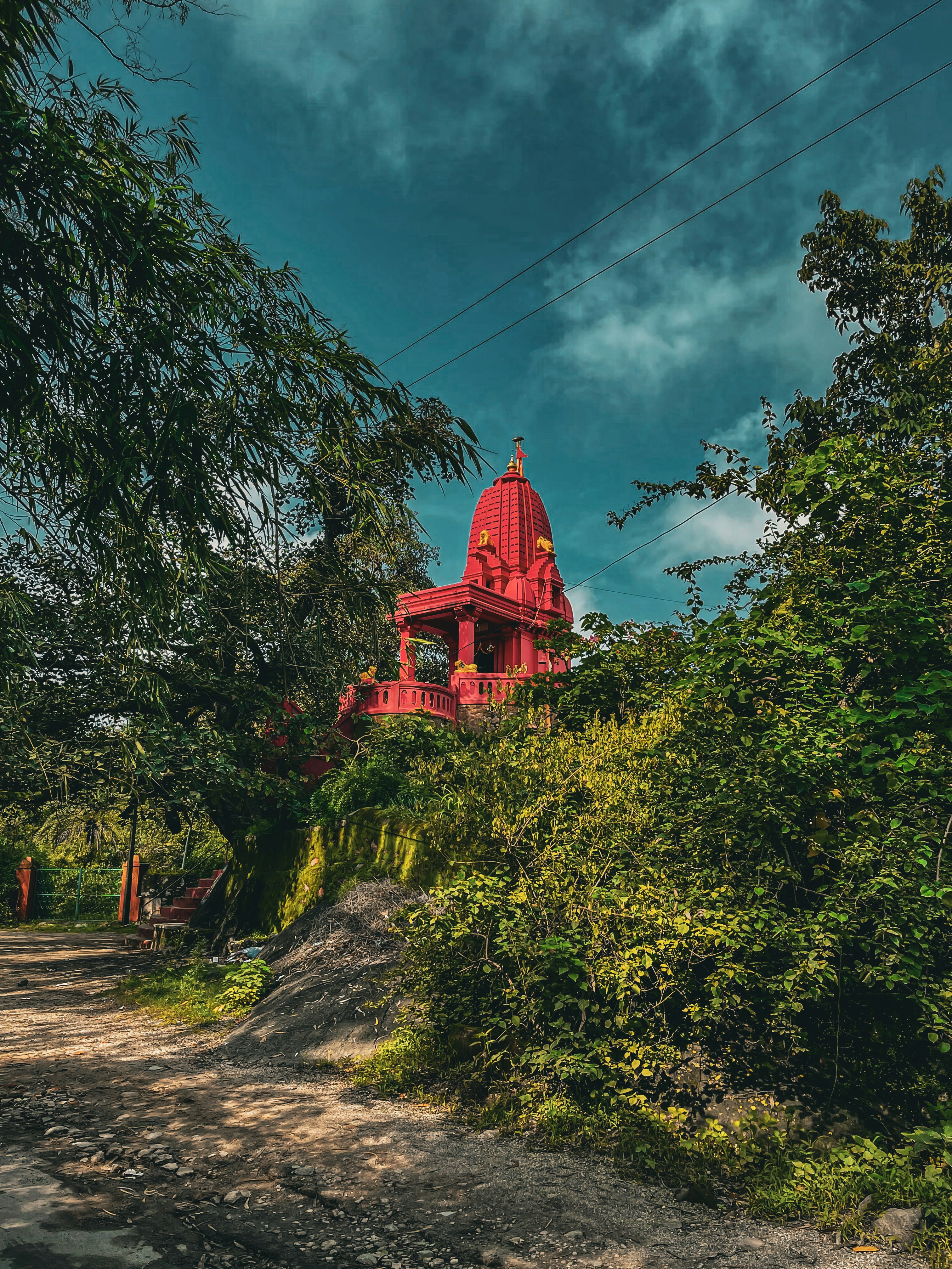 Crimson Temple Rising Above a Lush Green Terrace