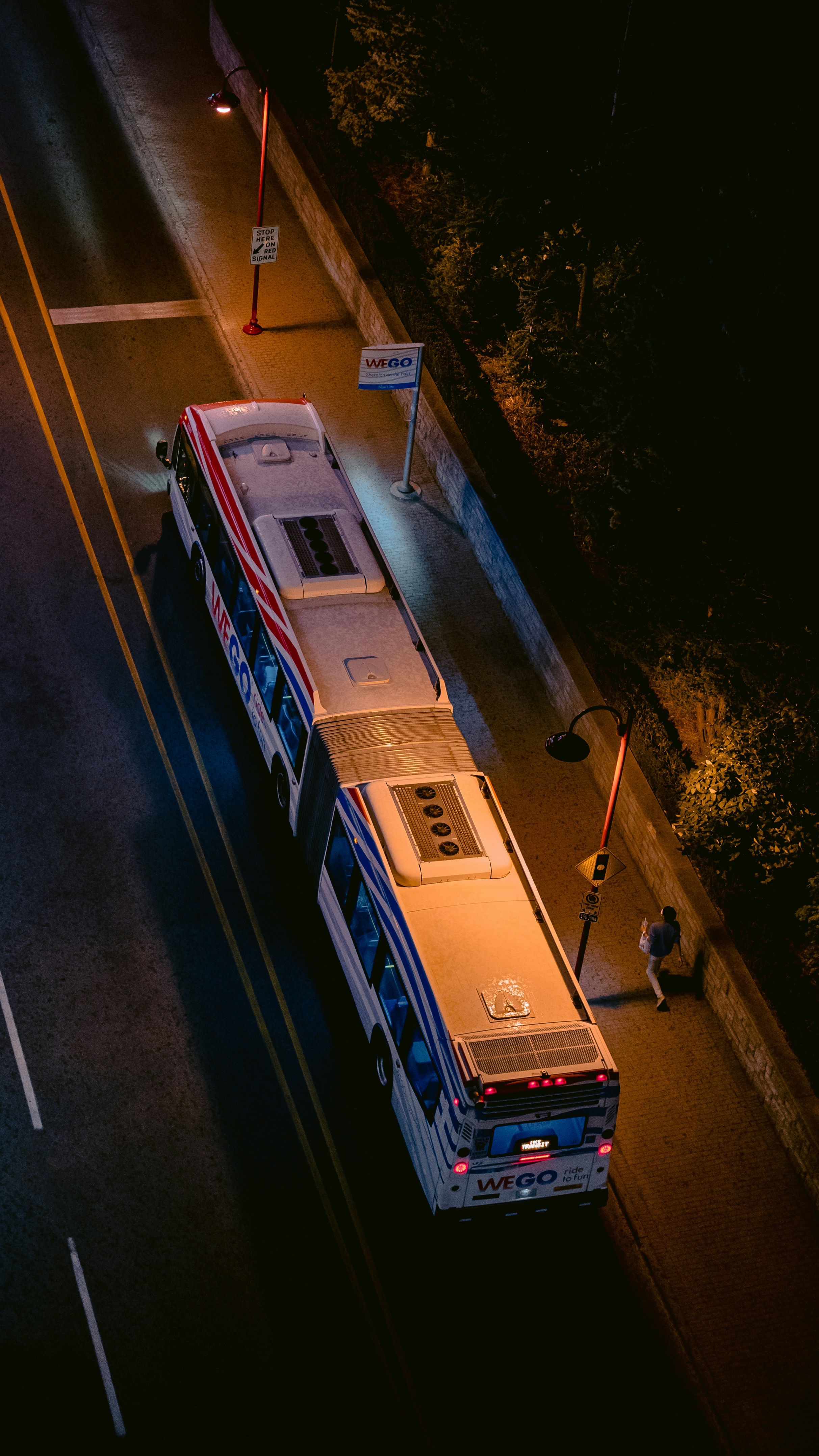 WeGo Night Run: A Diagonal Bus Bathed in Streetlight Glow