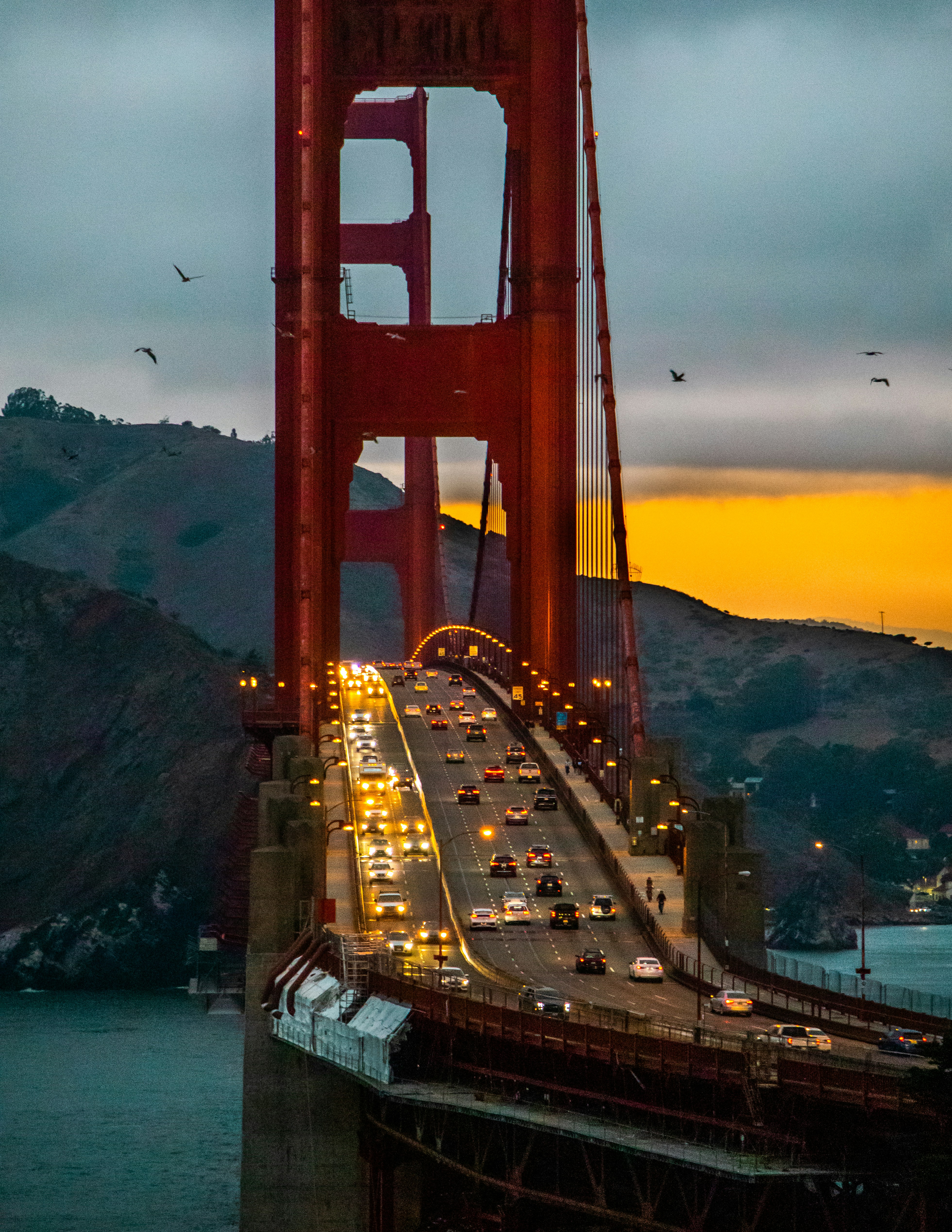 Crimson Tower at Dusk: Traffic Threaded Across the Golden Gate