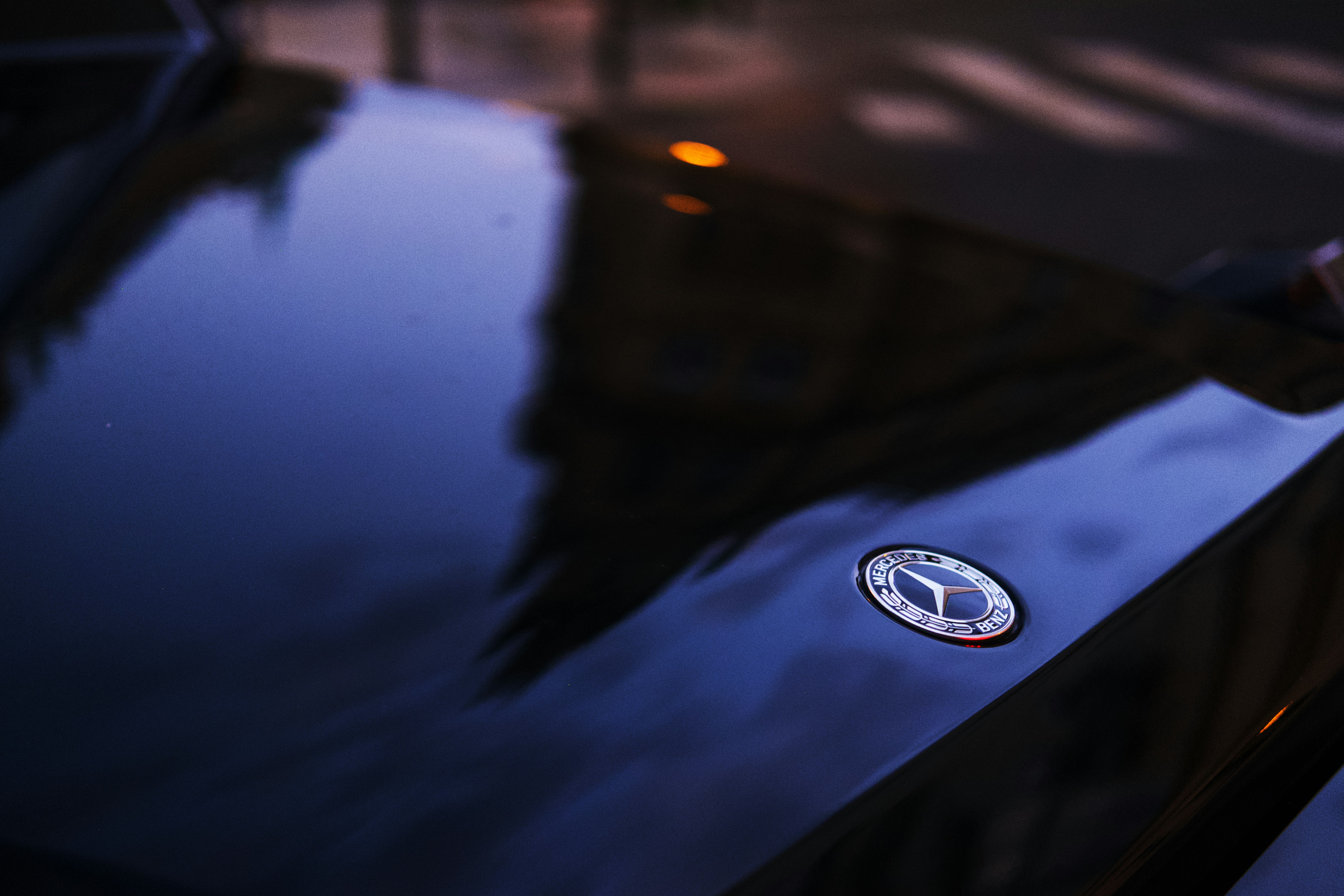 Midnight Reflection: The BMW Emblem on a Velvet Blue Hood
