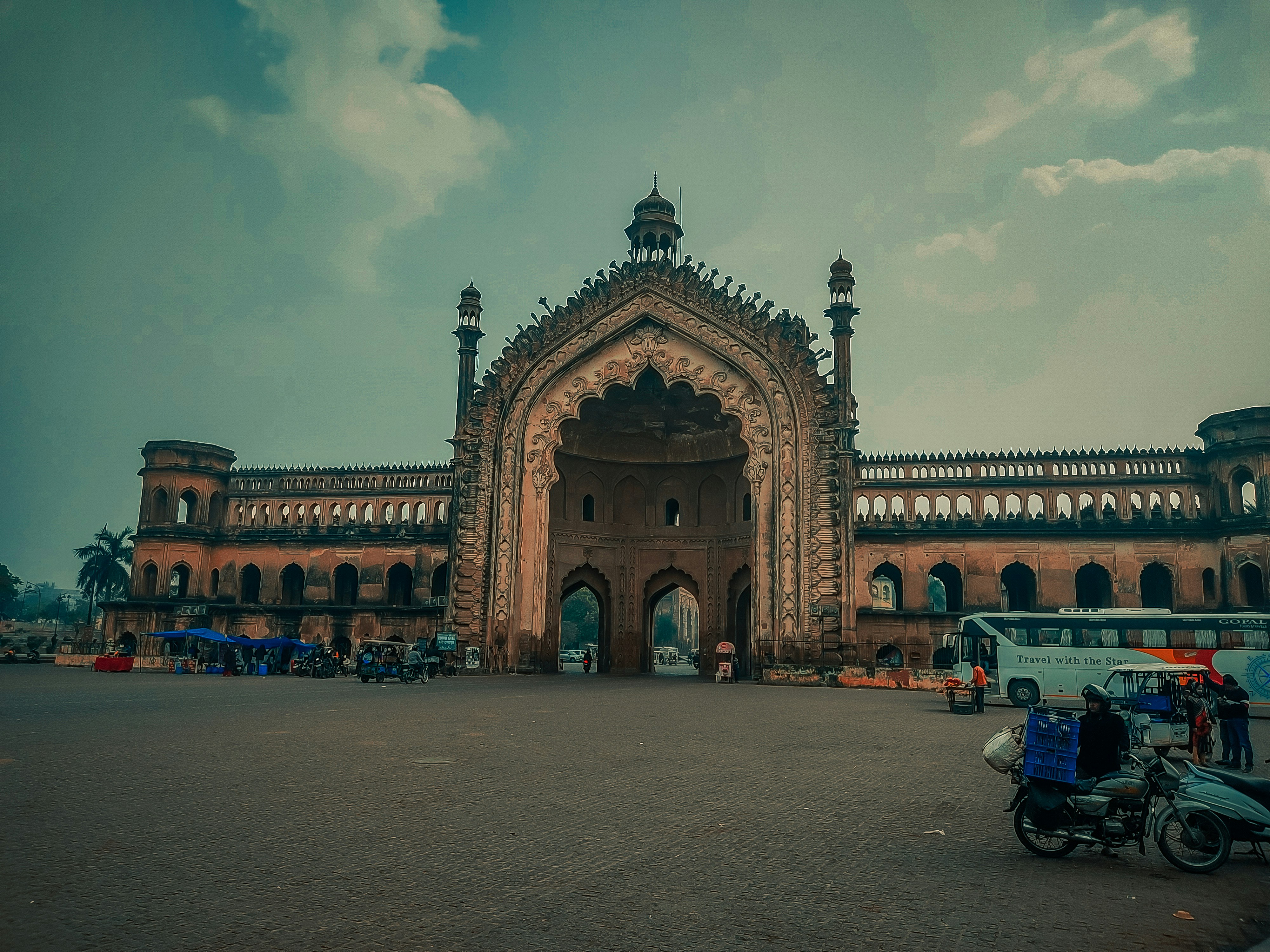 Red-Brick Gateway: A Timeless Arch Over a Bustling Square