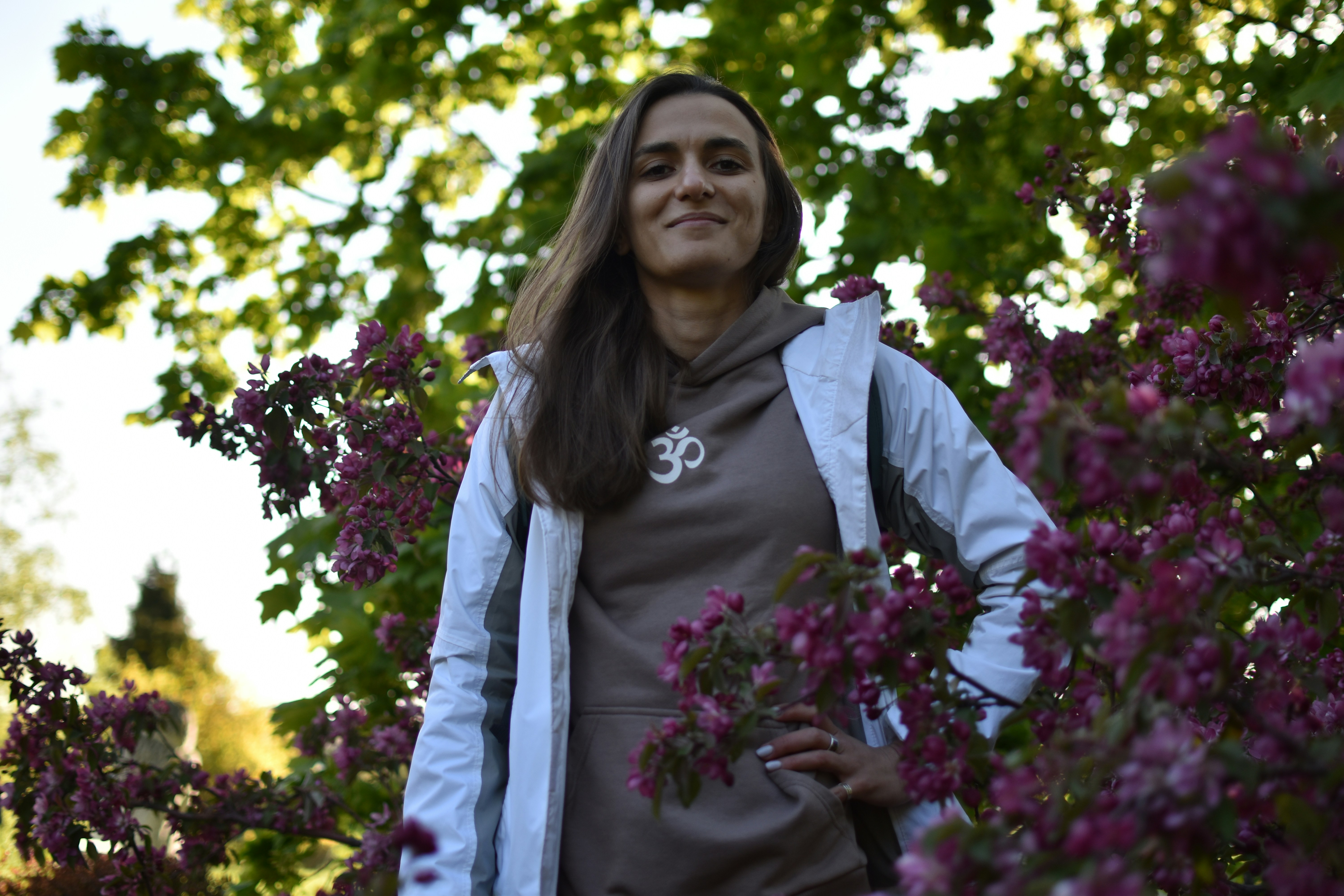 A person standing in front of a bush with purple flowers photo – Free ...
