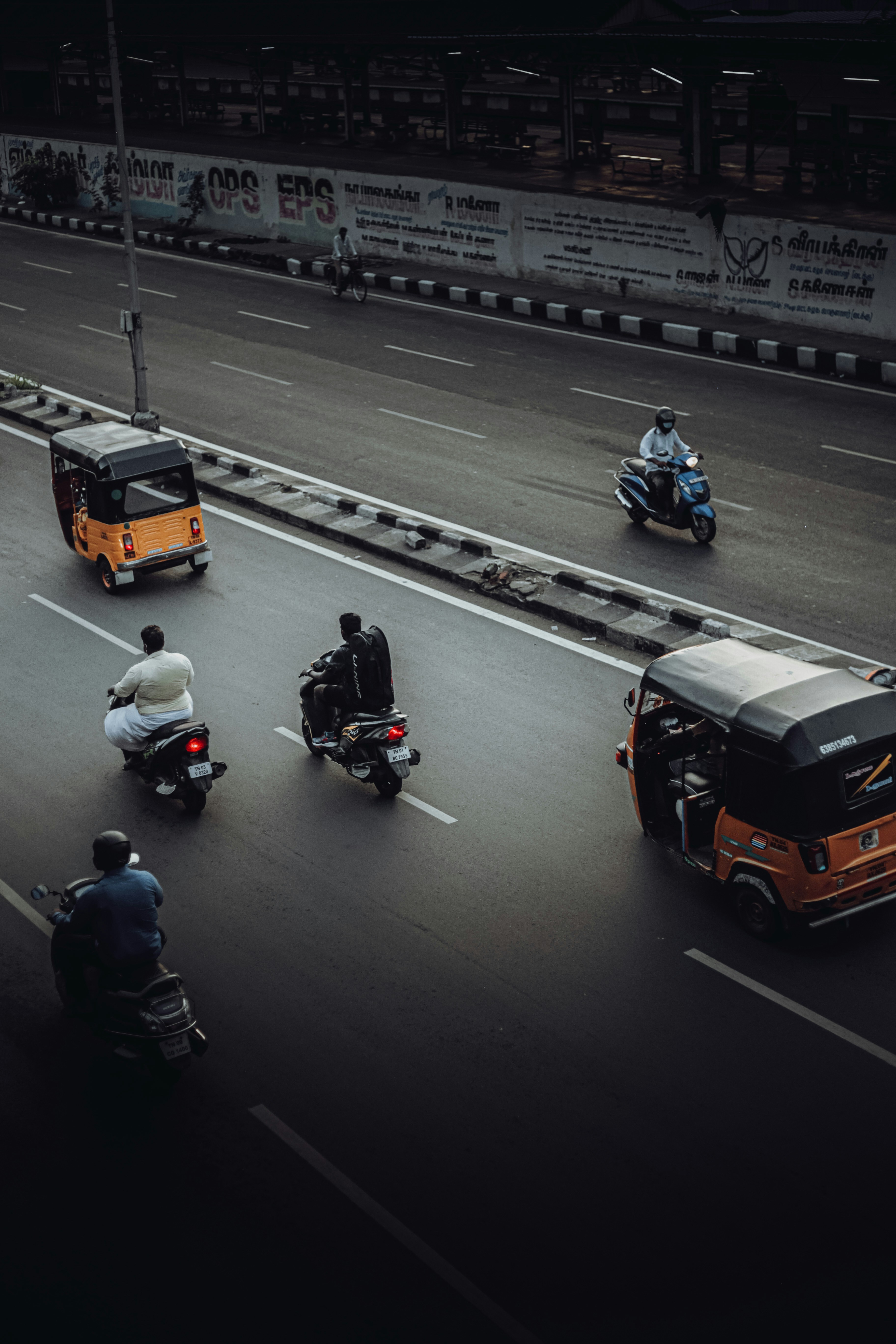 A group of people ride motorcycles down a street photo – Free Grey ...