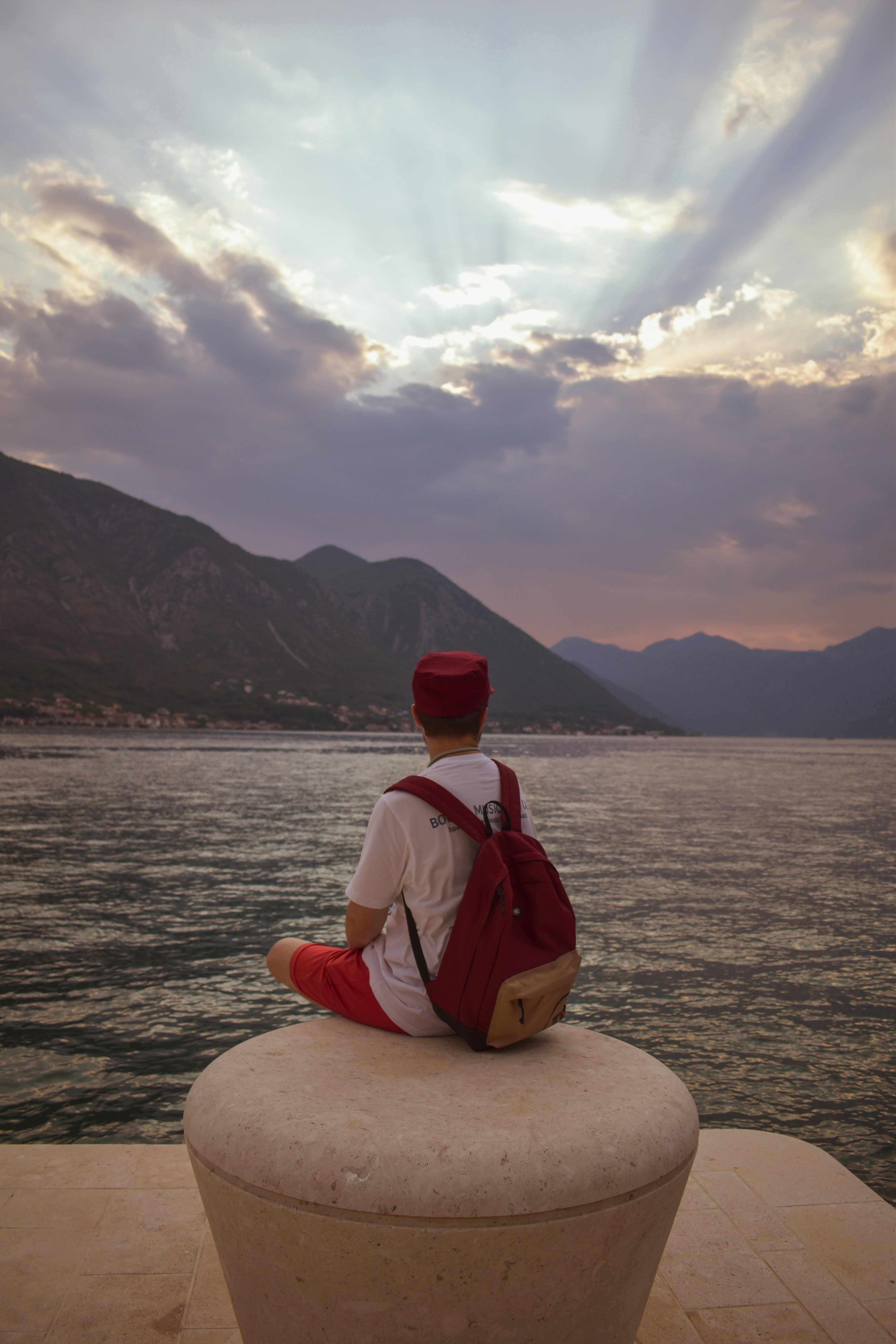 Red Backpack at Dusk: A Quiet Moment Along the Lakefront