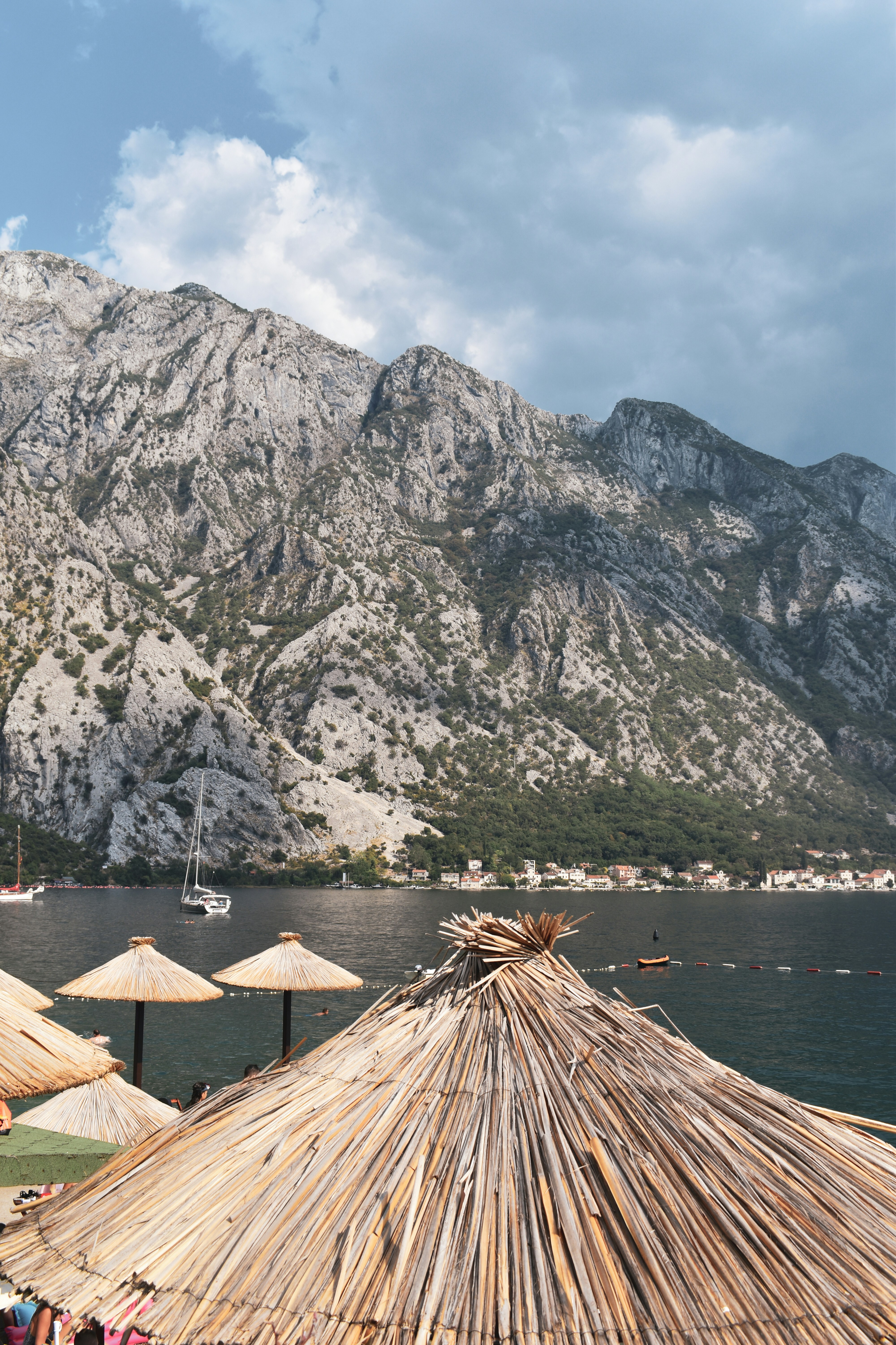 Thatched Beachfront Beneath Tall Peaks
