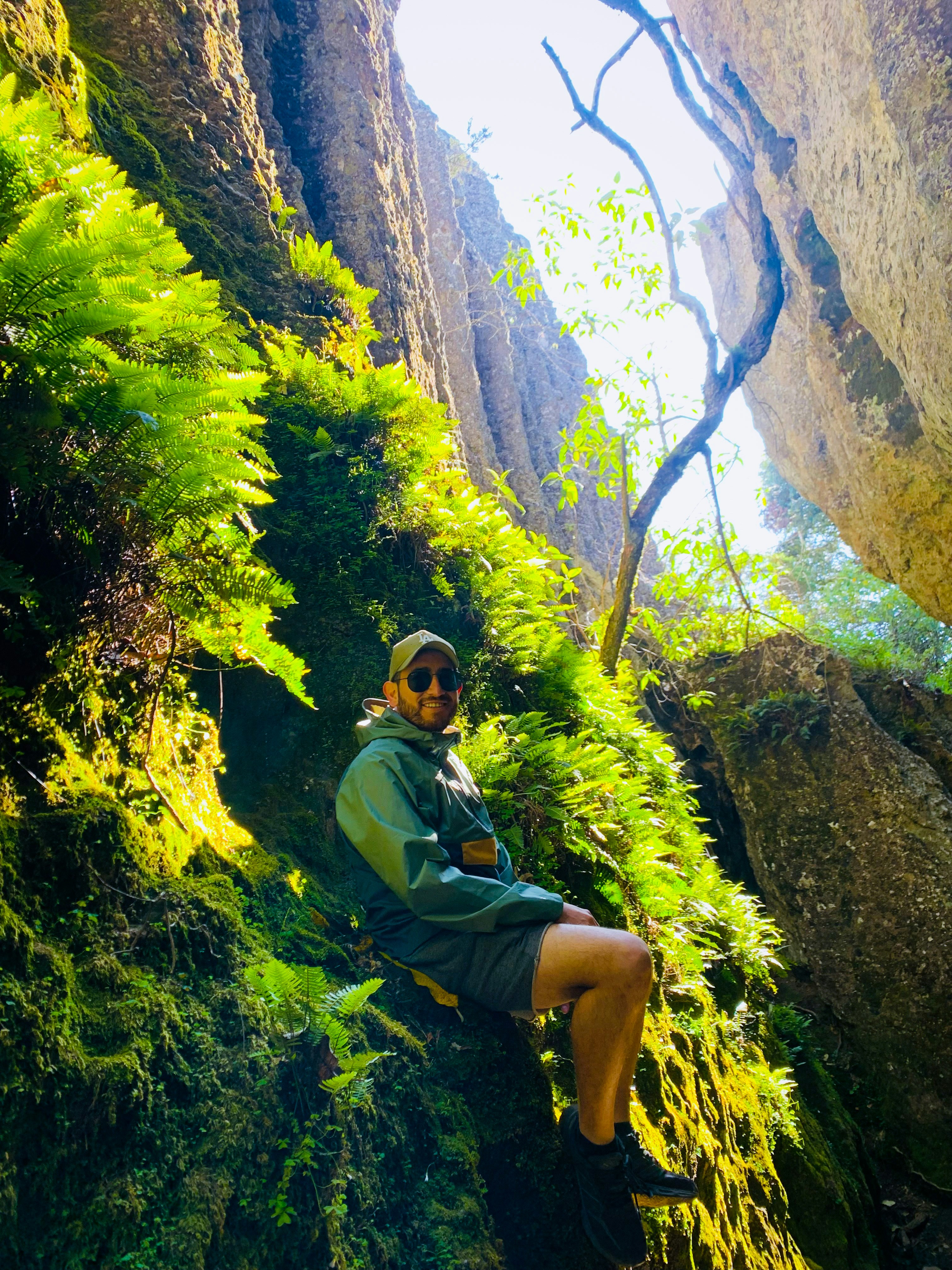 a man sitting on a rock ledge