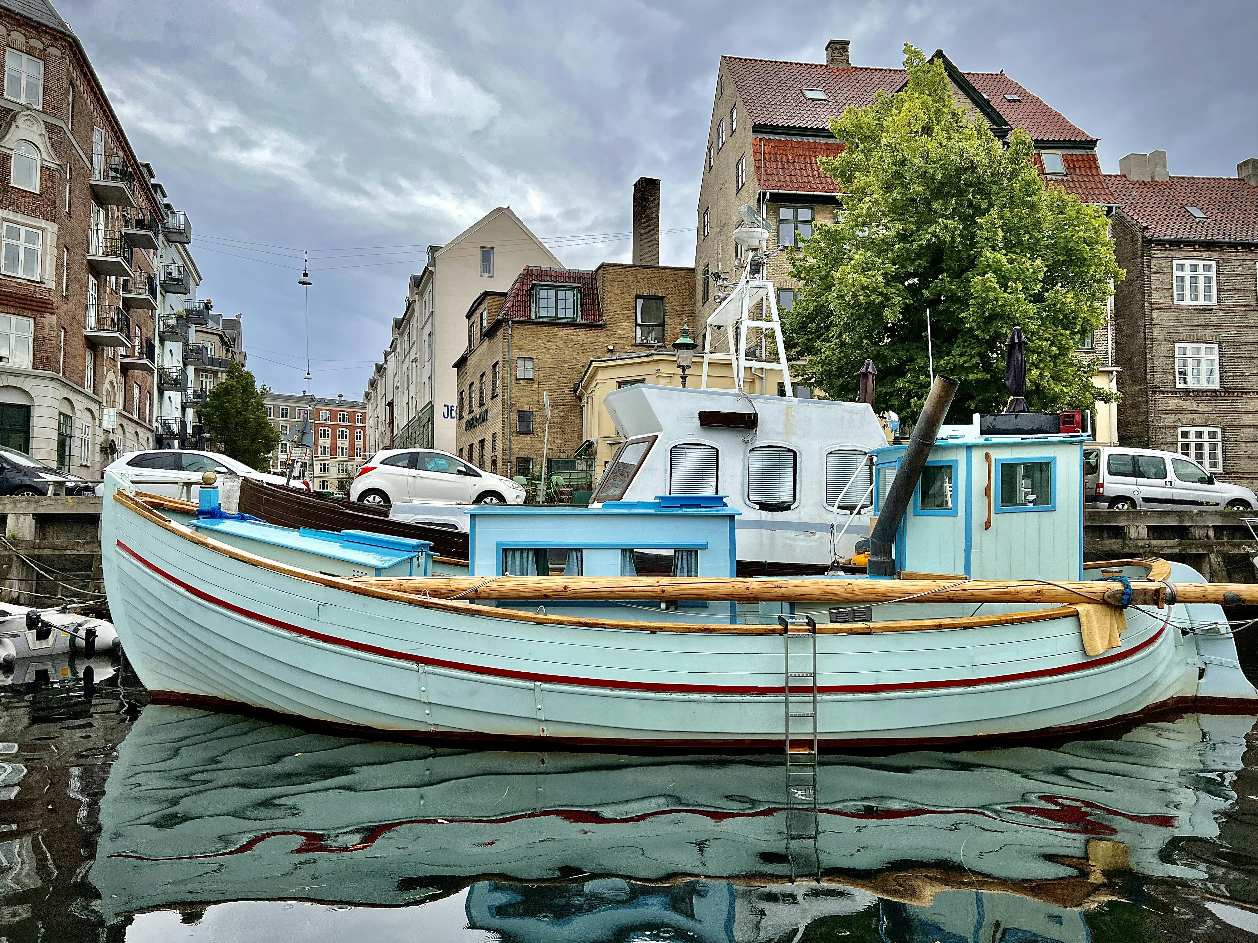 Docked Boat with Urban Backdrop: A Quiet Harbor in Soft Light