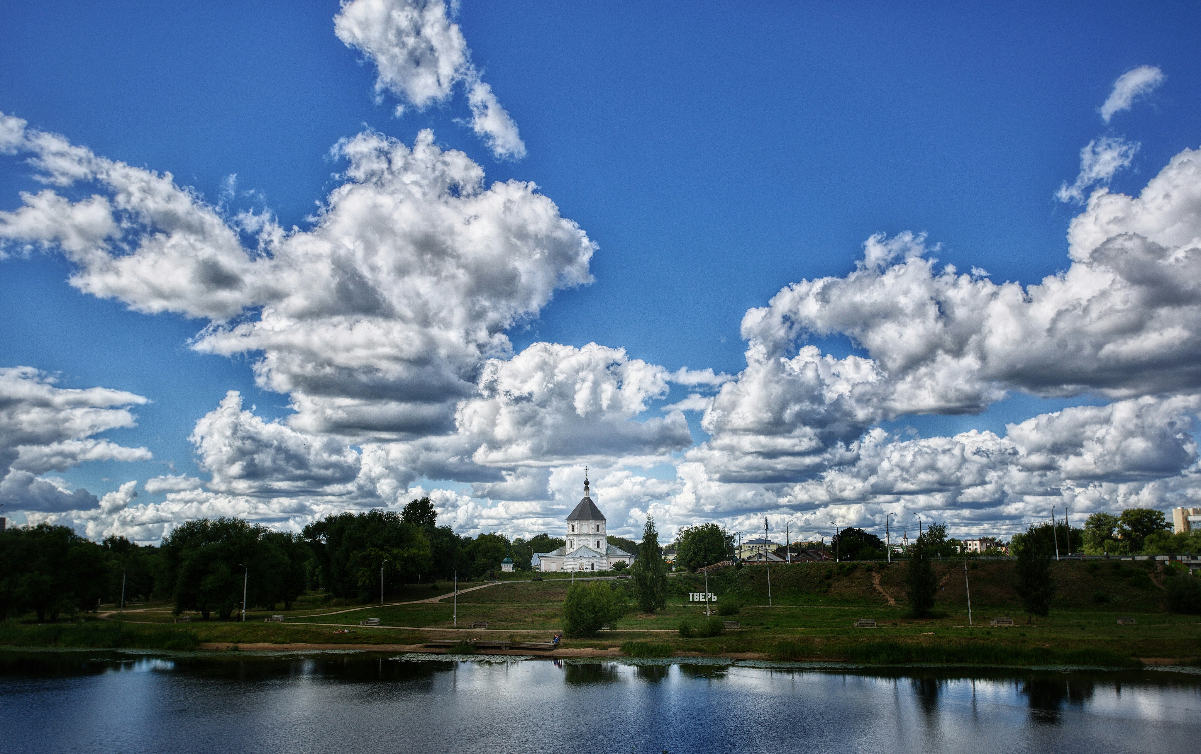 White Dome on the Riverside: A Quiet Moment Under Luminous Clouds