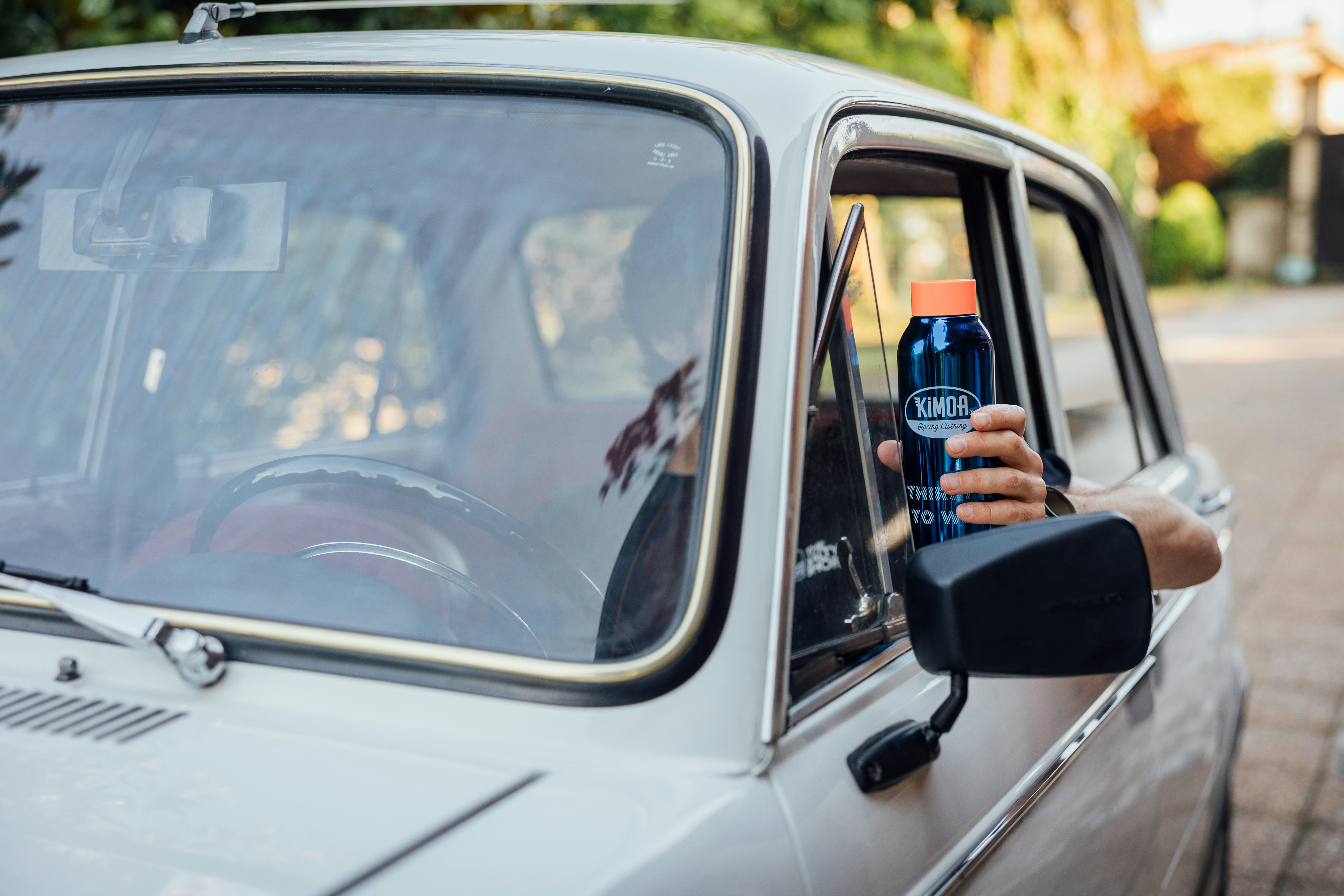 Retro Ride, Fresh Brew: A handoff through a vintage car window