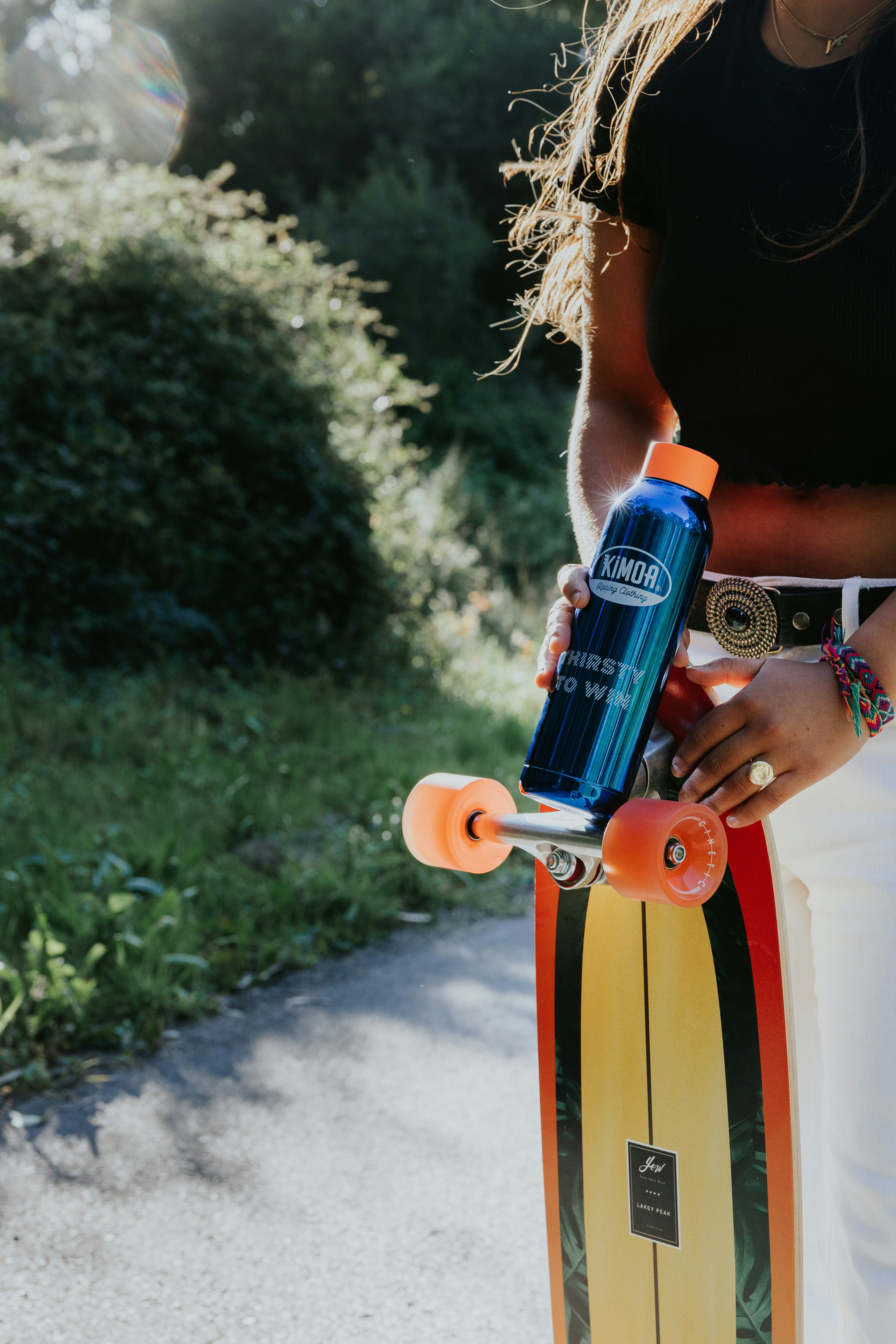 Sunlit Ride: A Glide of Colorful Skates and a Water Bottle in Morning Light