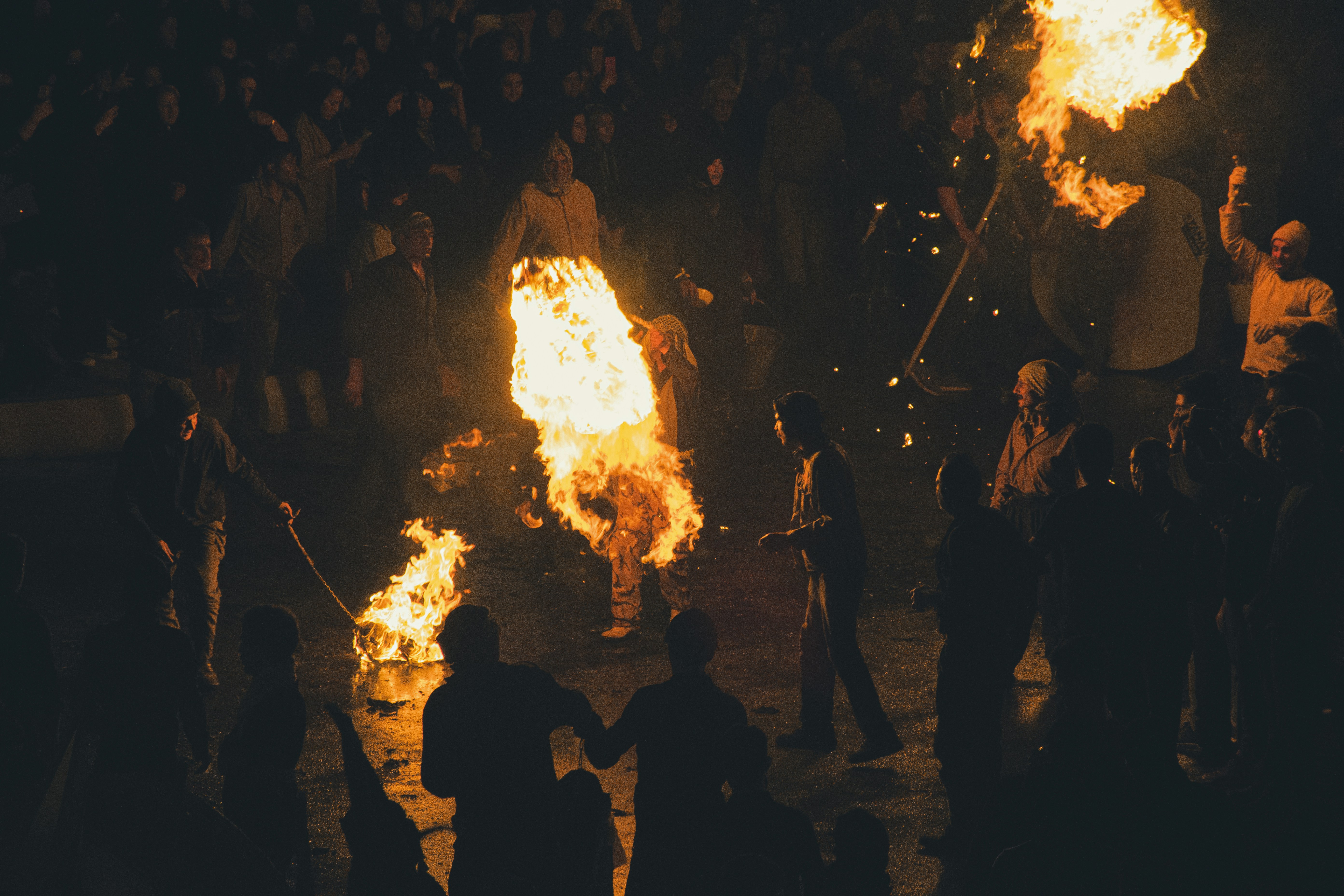 A group of people around a fire photo – Free Shishavan Image on Unsplash