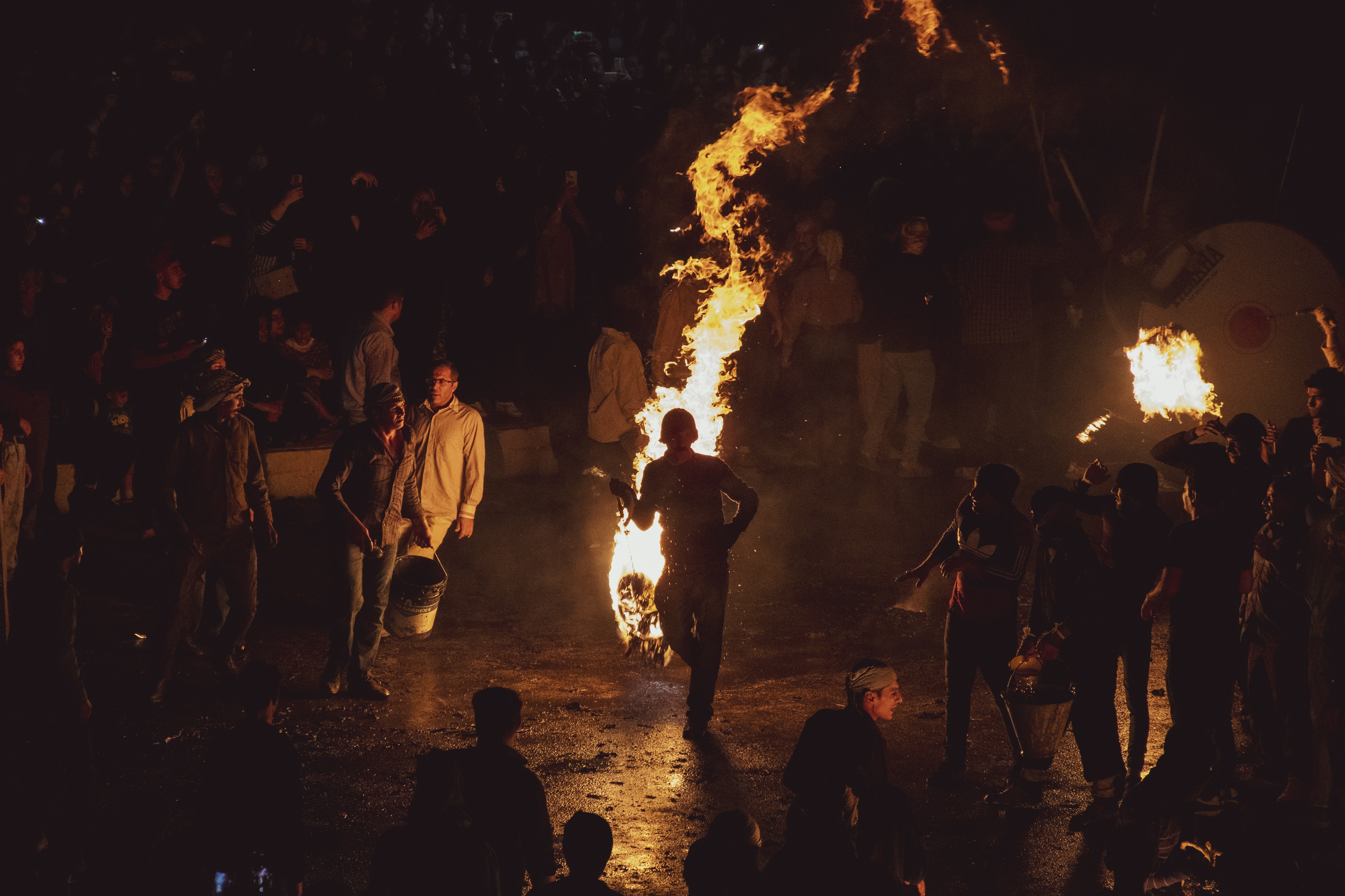 A group of people around a fire photo – Free Shishavan Image on Unsplash
