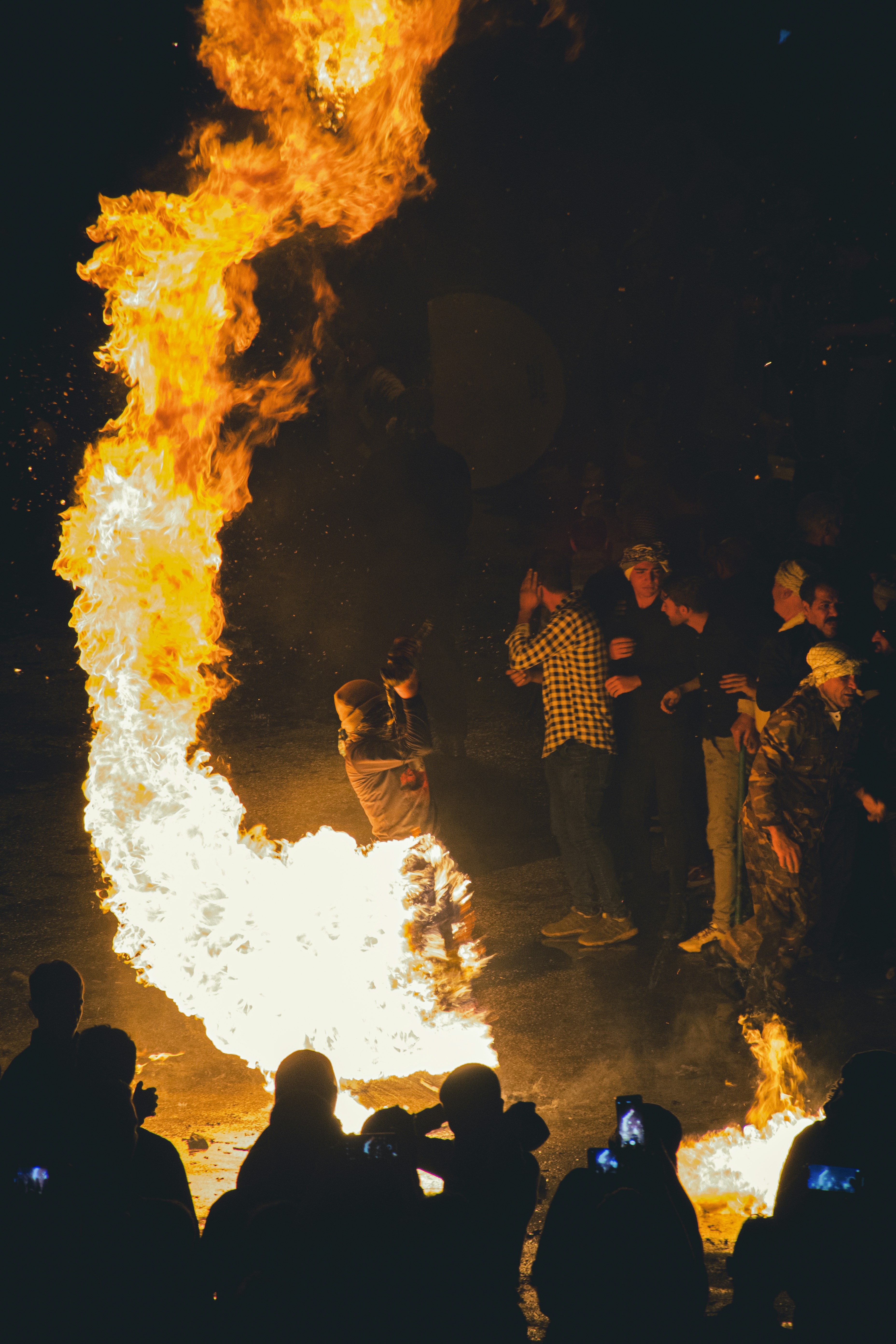 A group of people standing around a fire photo – Free Shishavan Image ...