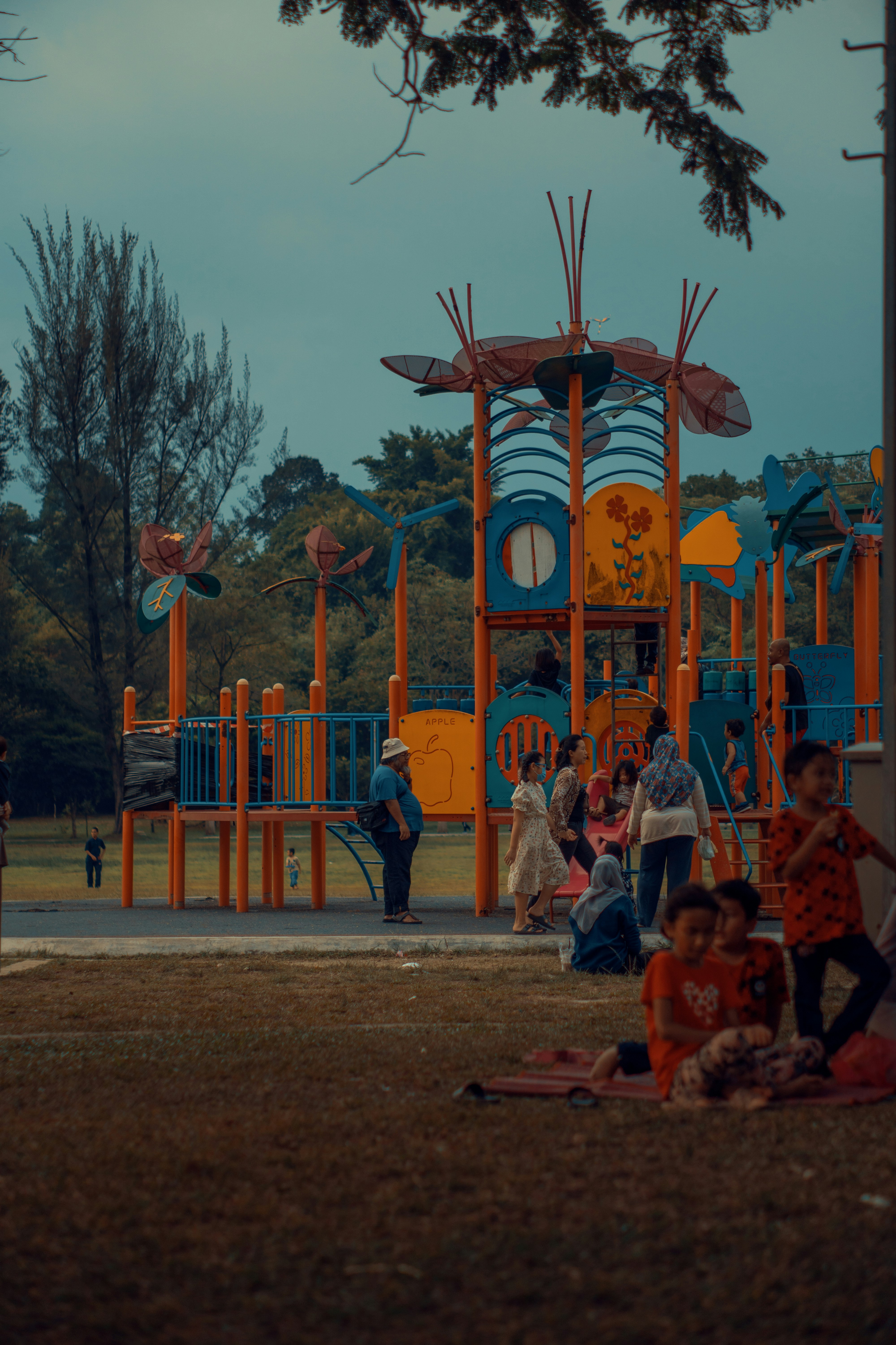 Color-Rich Play Tower Amid a Lively Park Evening
