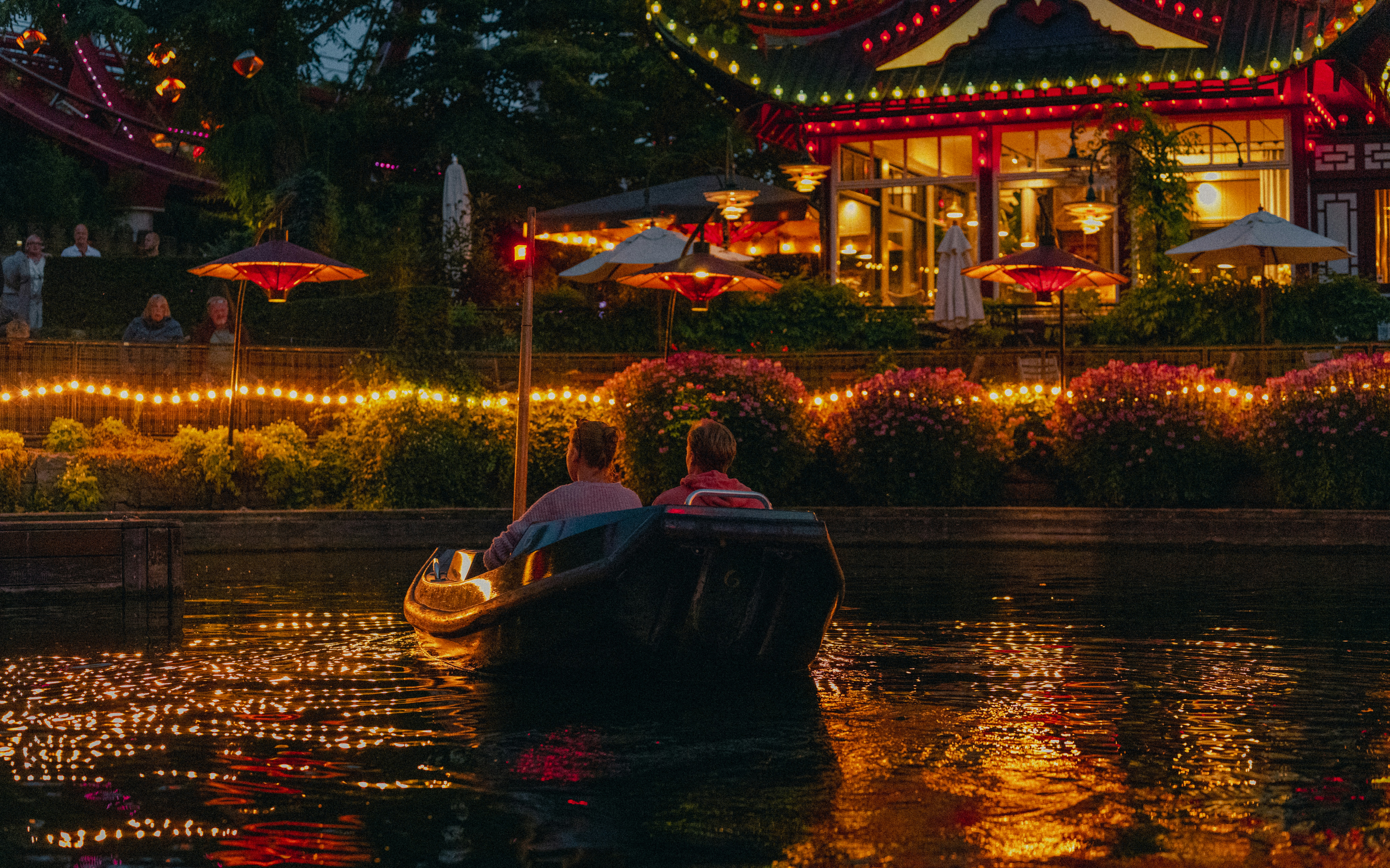 Lantern-lit Boat Glide Under Riverside Pavilion Lights