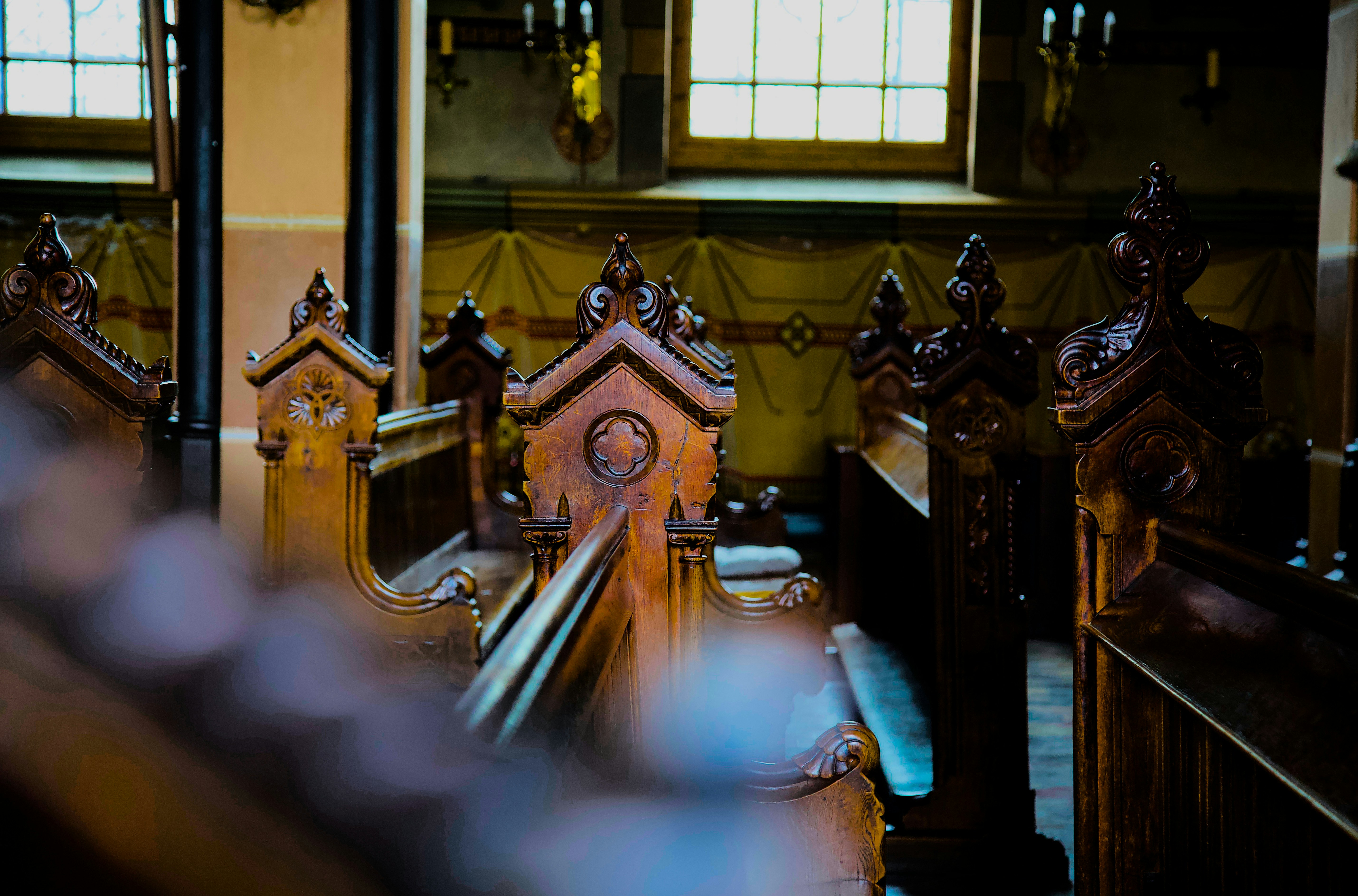 Intricately carved wooden church pews create a serene atmosphere, inviting contemplation and reflection.