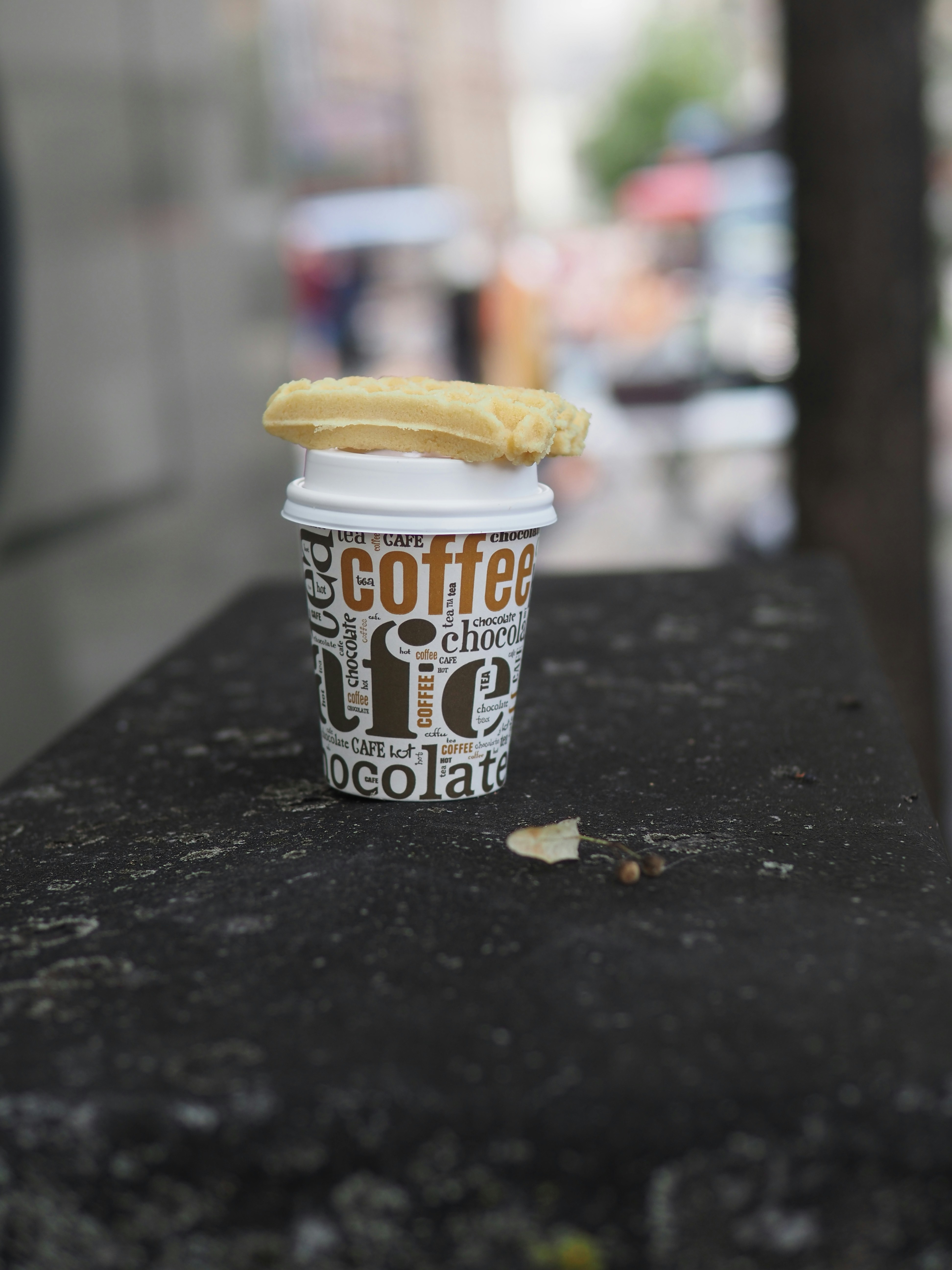 A Morning Coffee Cup Balancing on City Concrete