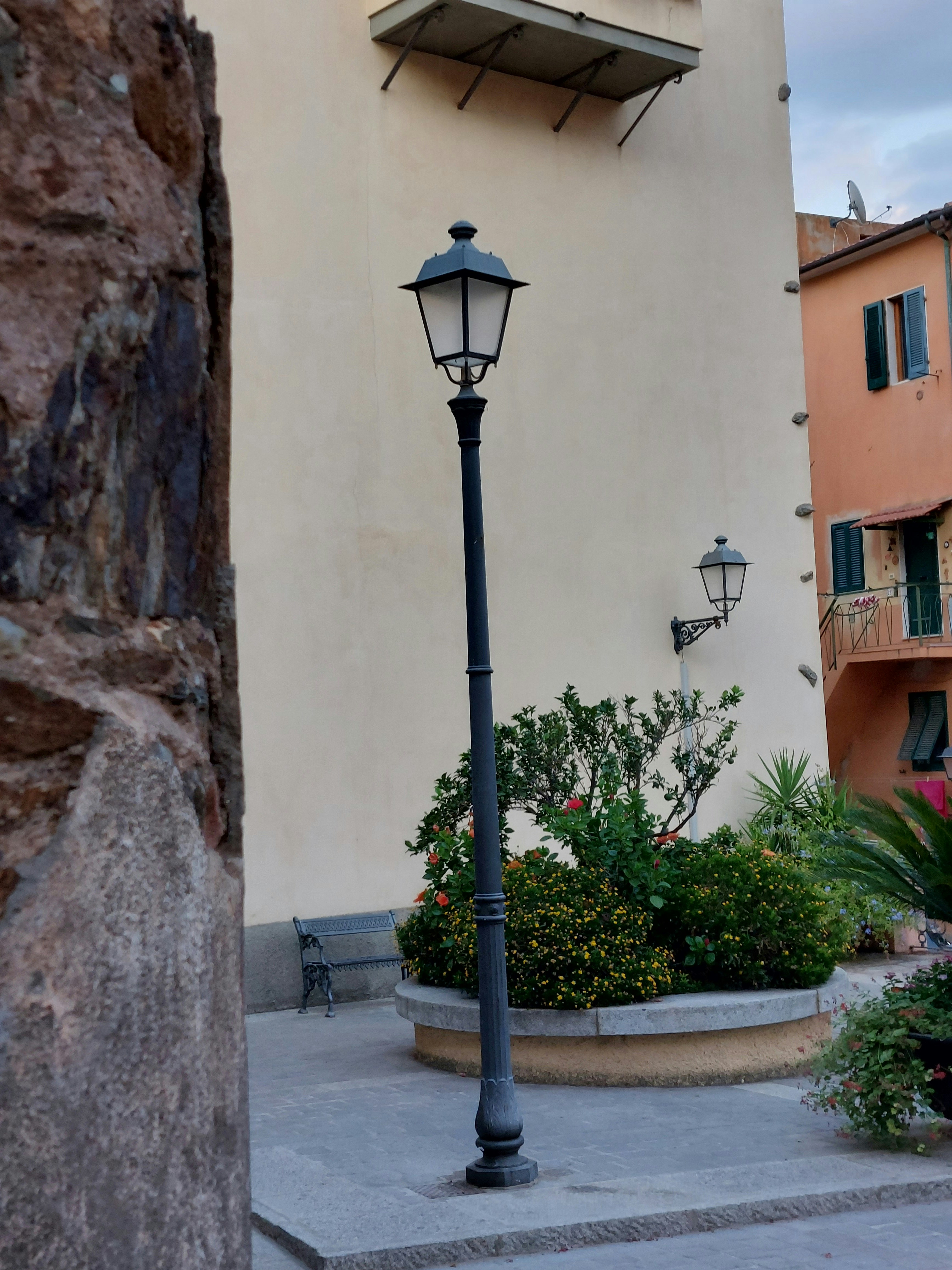 Lanterns and Stucco: A Quiet Piazza Between Stone and Orange Facades