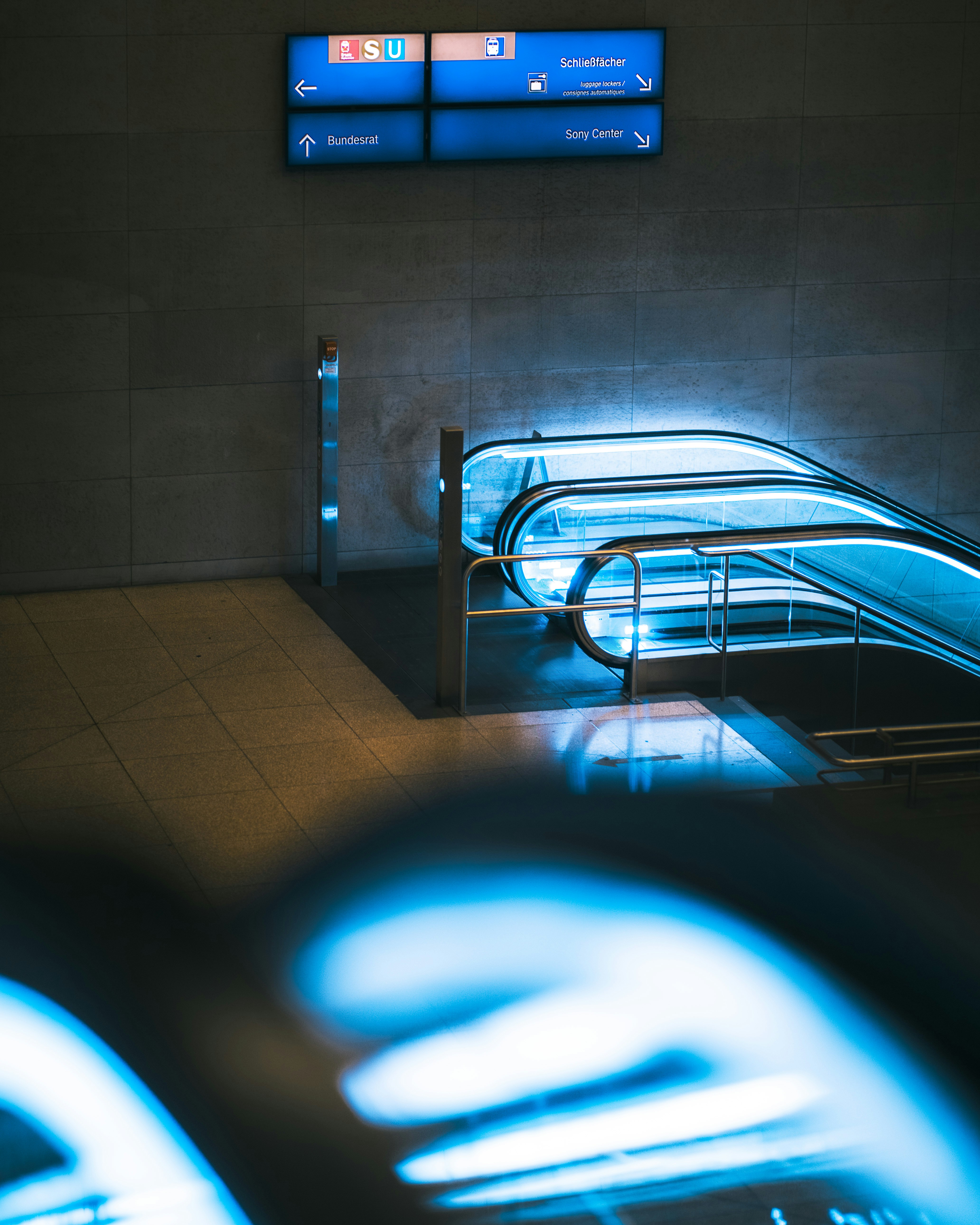 Blue Hour Glide: An Empty Escalator Under Neon Signage