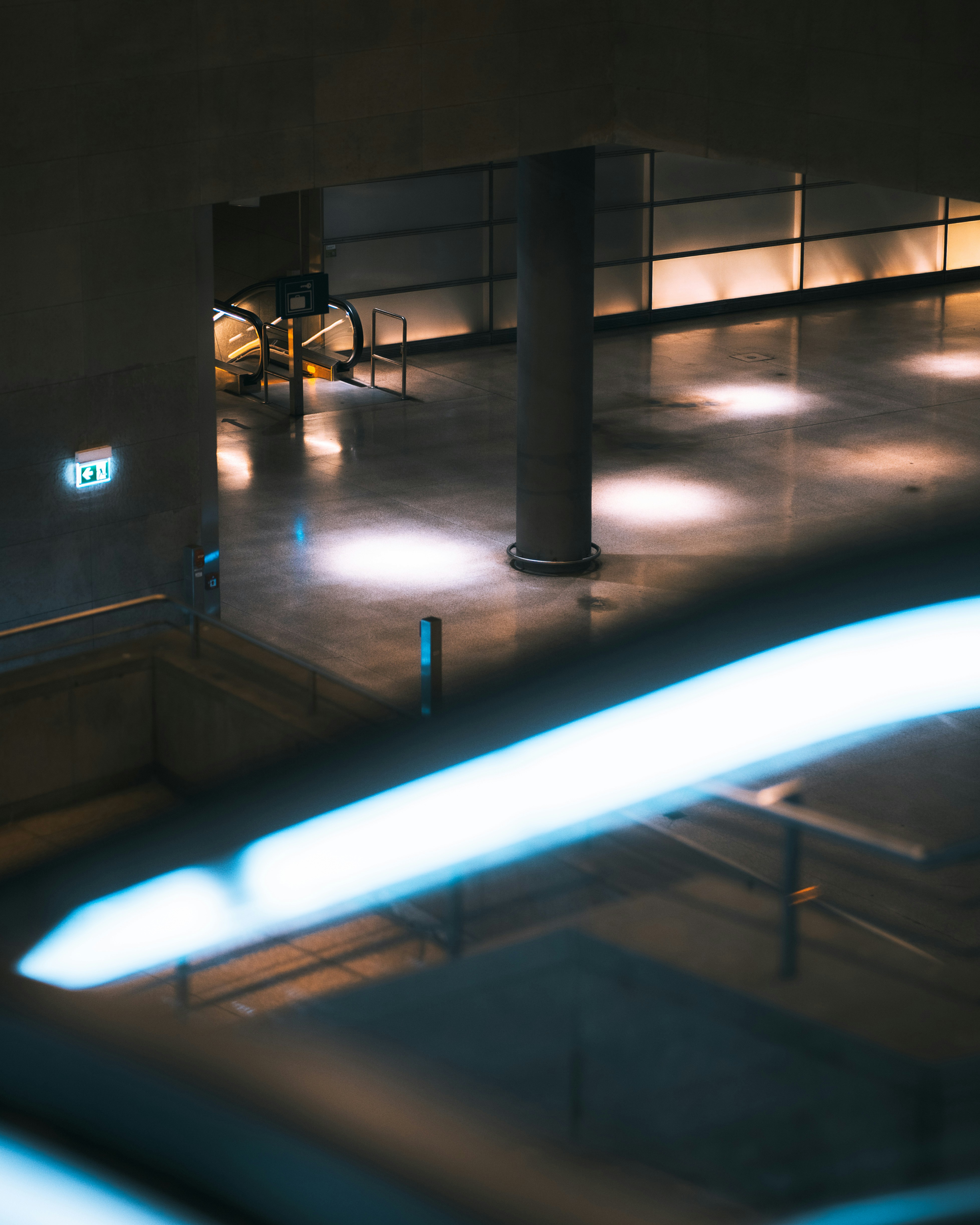 Neon Ribbon Across a Quiet Concrete Atrium