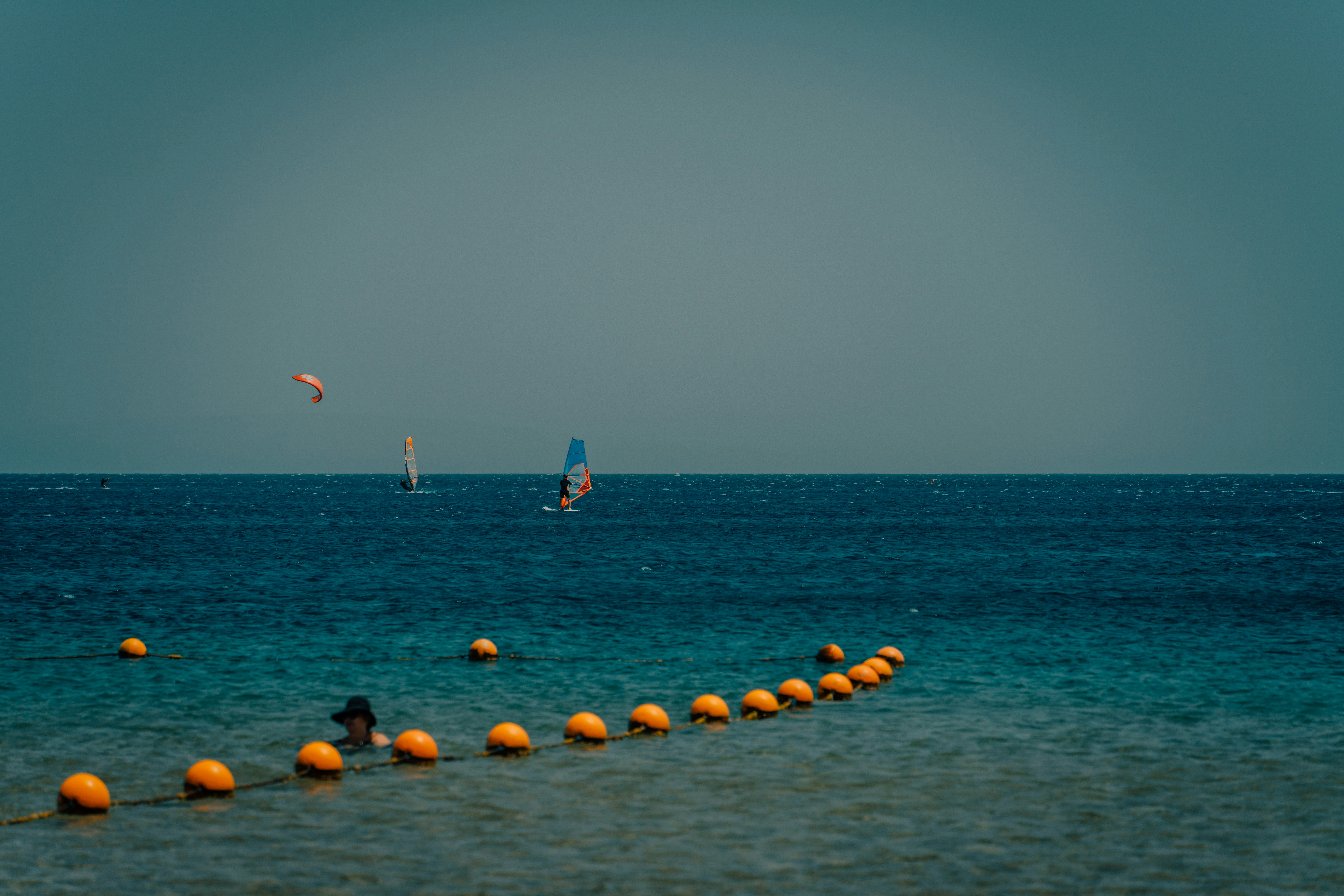 Arc of Orange Buoys Across a Turquoise Sea