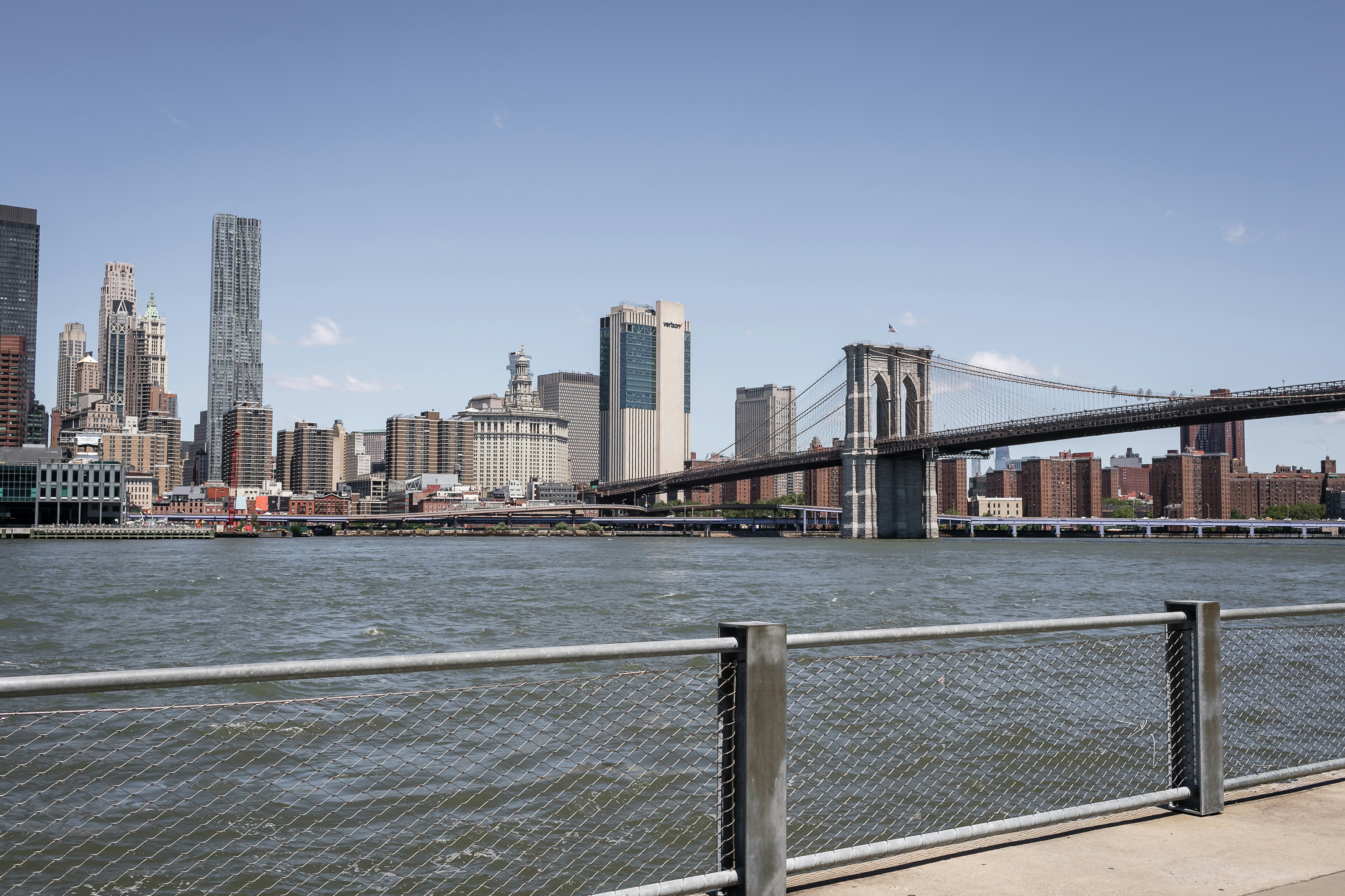 Riverside View: Brooklyn Bridge Linking the East River to a Modern Manhattan Skyline
