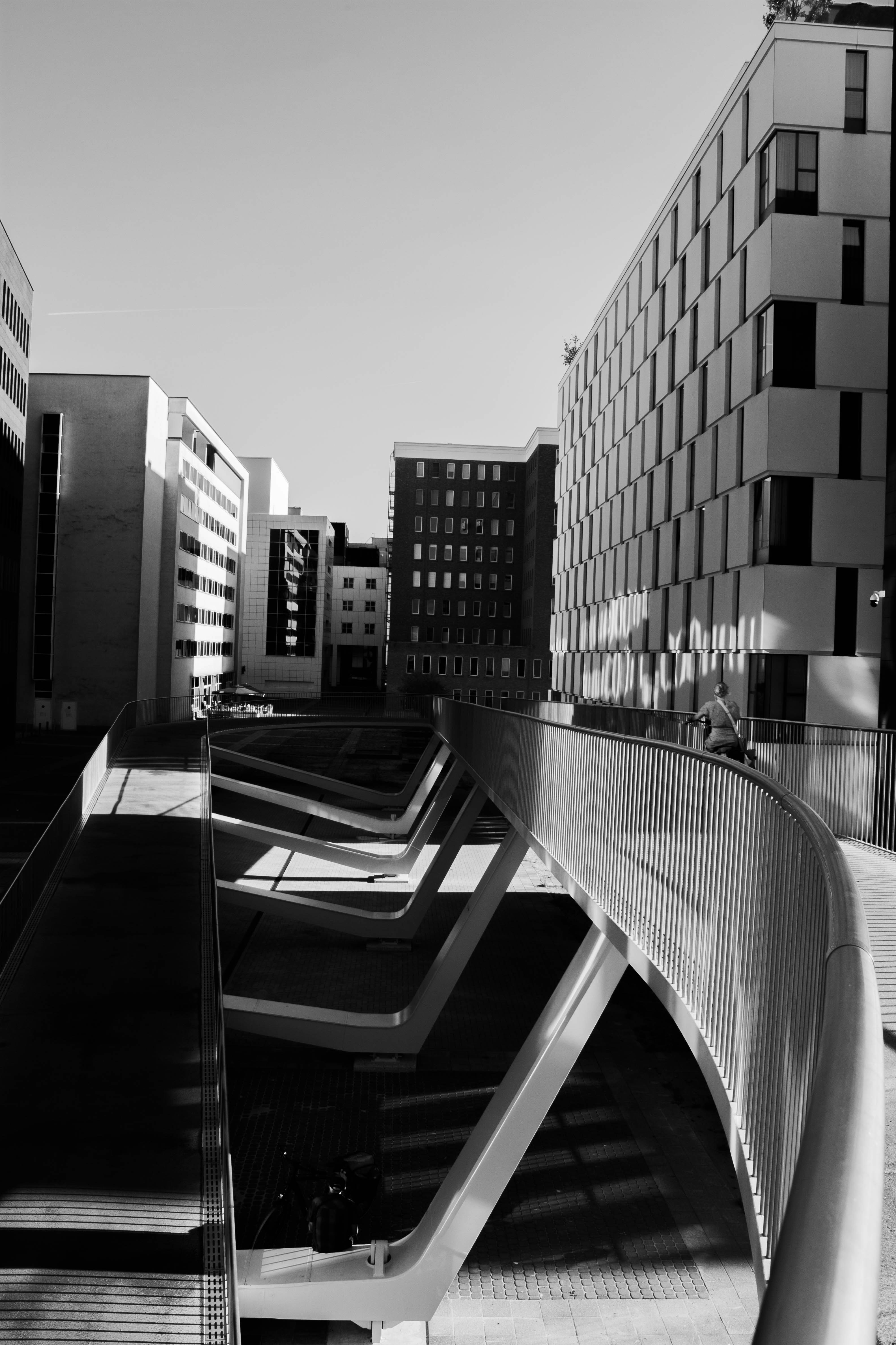 A bridge with a railing and buildings photo – Free Grey Image on Unsplash