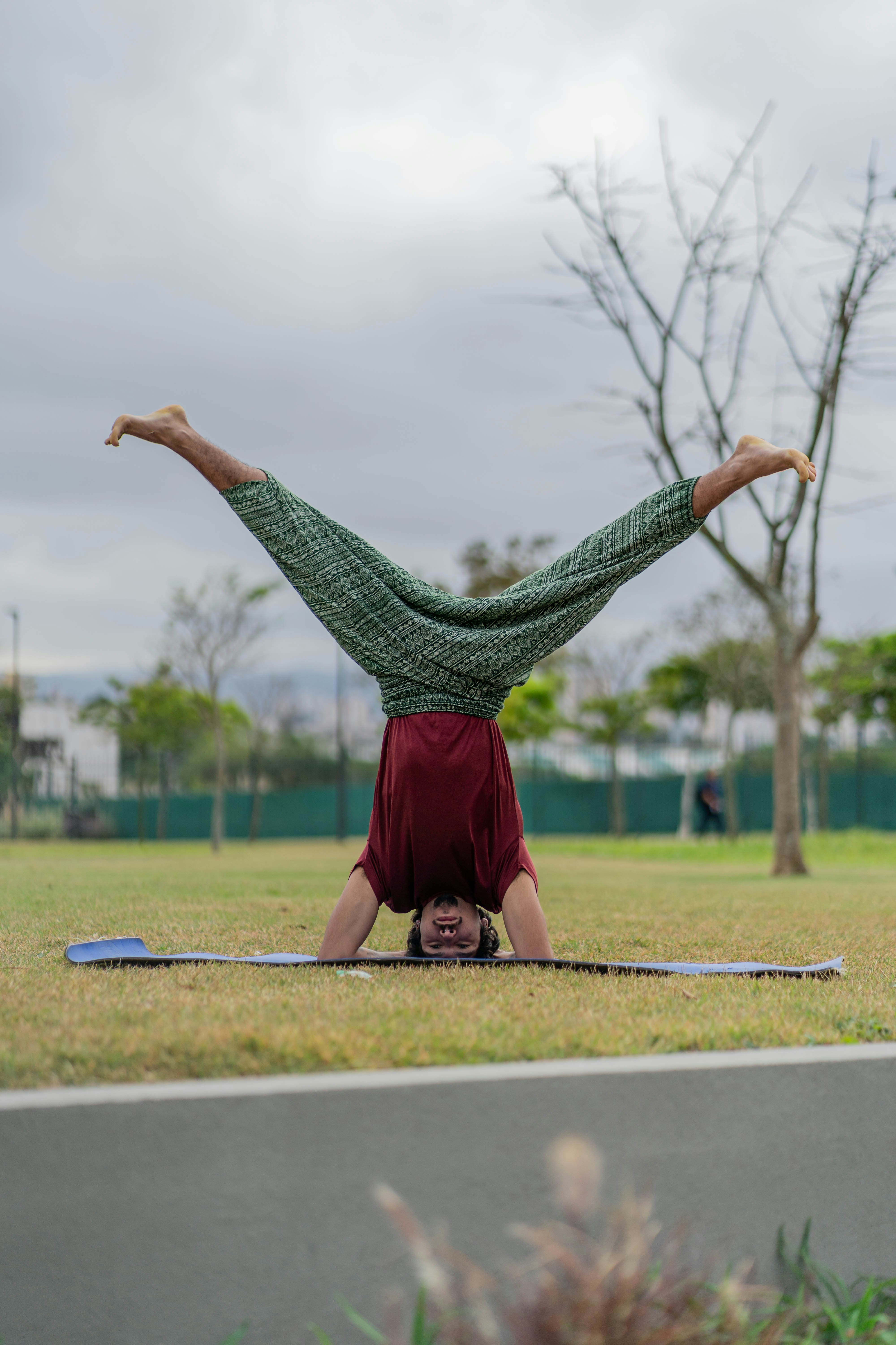 Upside-Down Focus: Headstand on a Mat in a Quiet Park