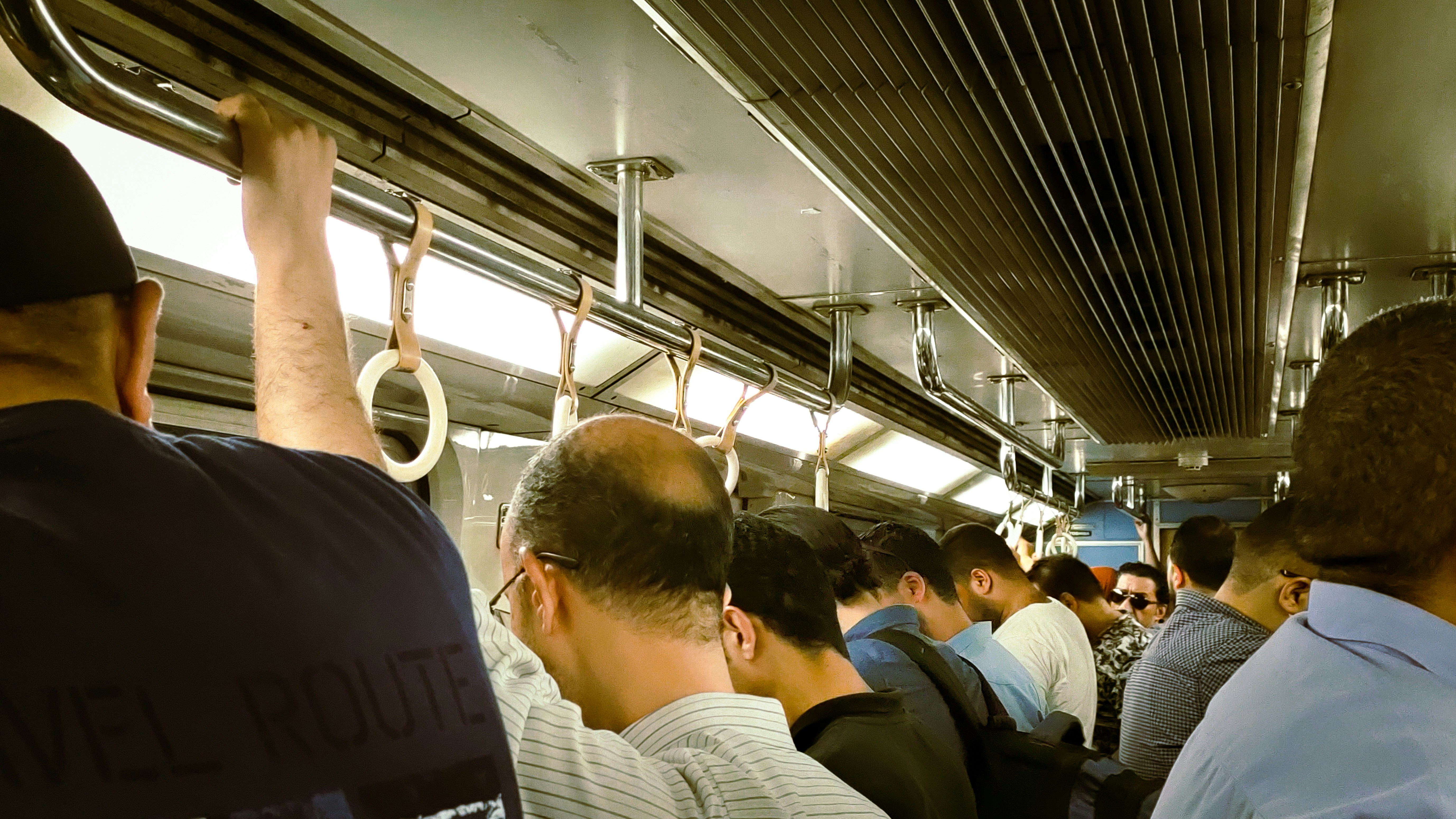 Focused Stillness Amid a Moving Subway Crowd