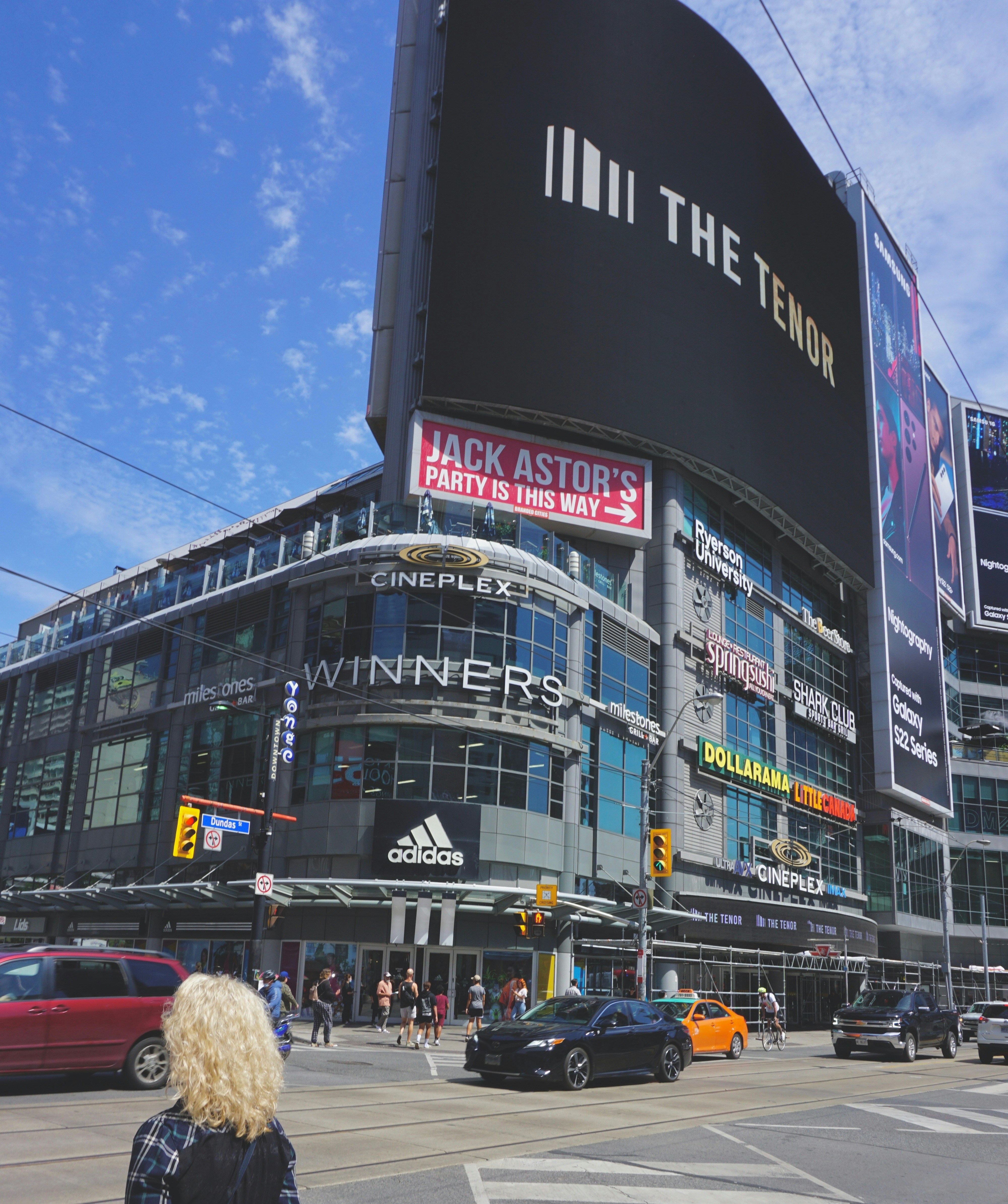 The Tenor Banner Over Dundas Square: Neon Edges and Glass Facades