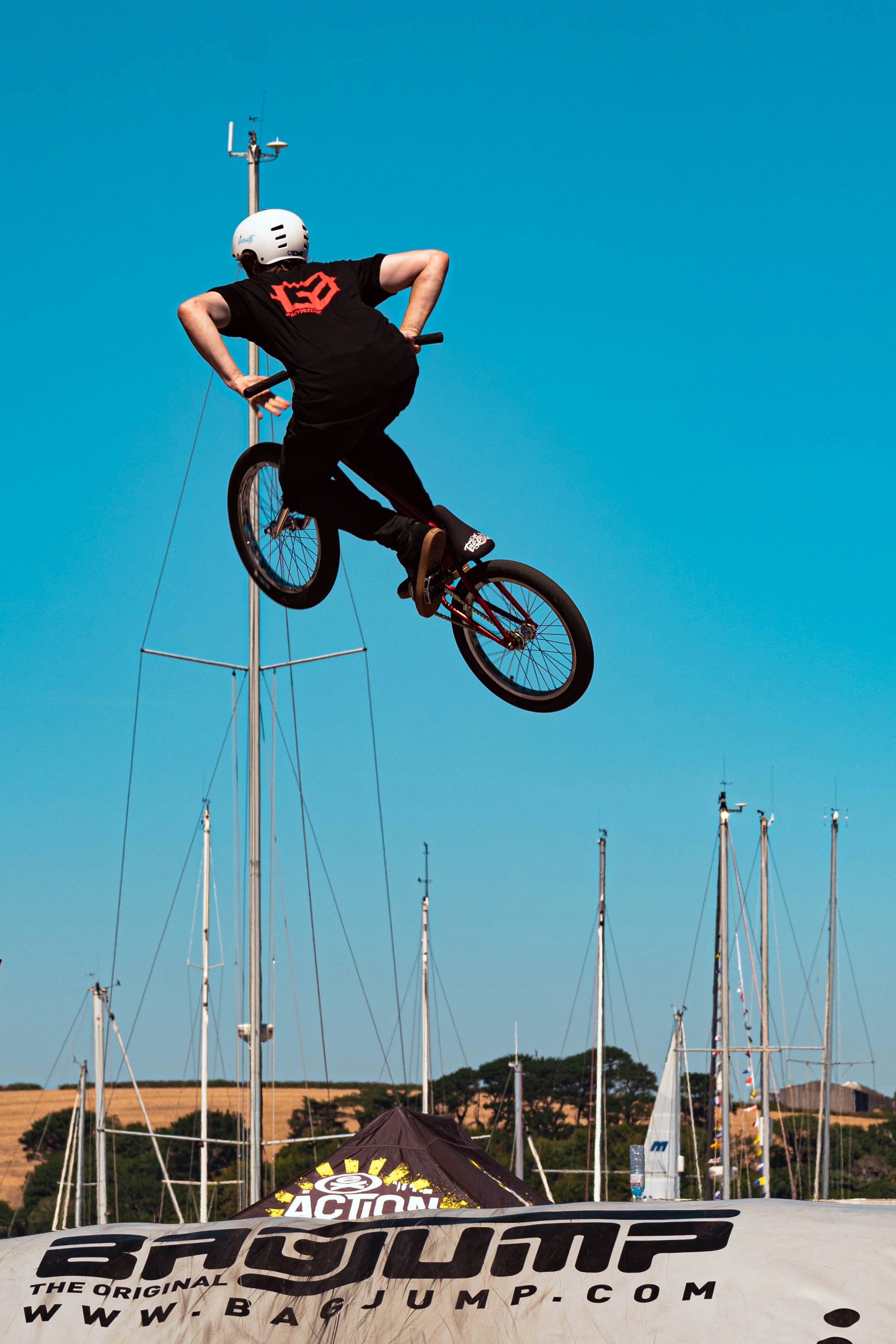 A man on a bike jumping over a ramp photo – Free Blue Image on Unsplash