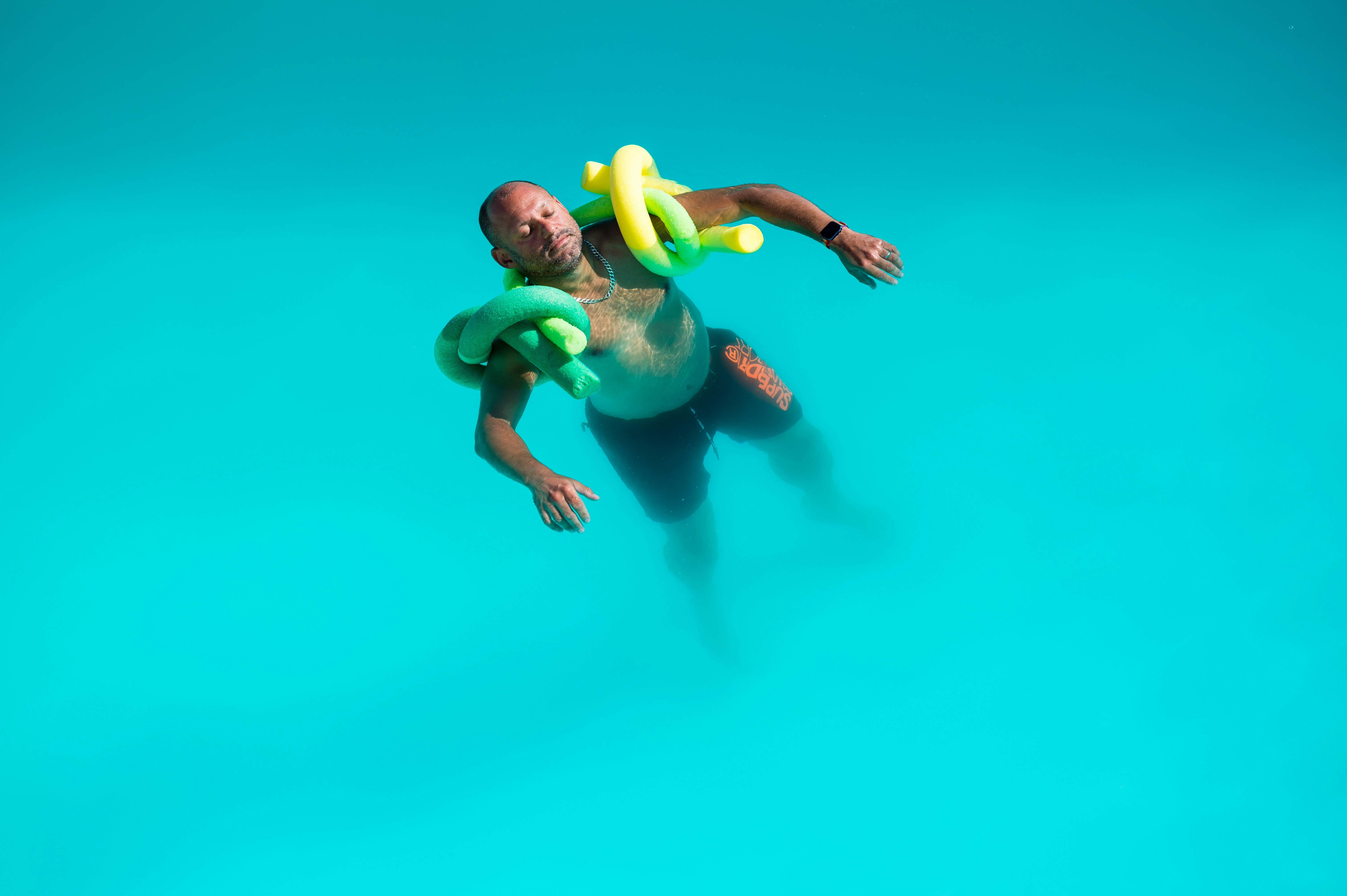 Neon Arm Floats Drifting Through Turquoise Waters