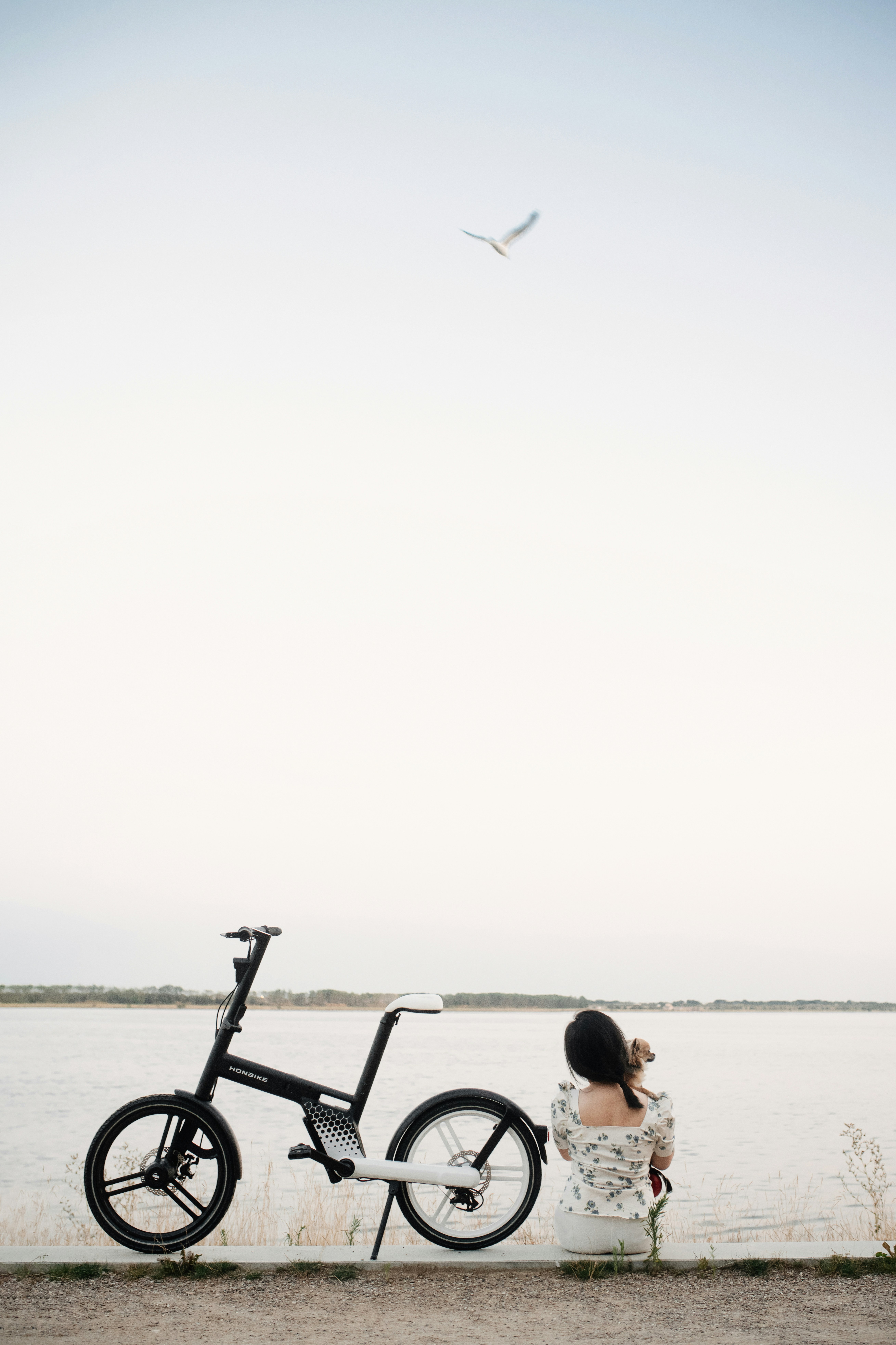 a person sitting next to a bicycle