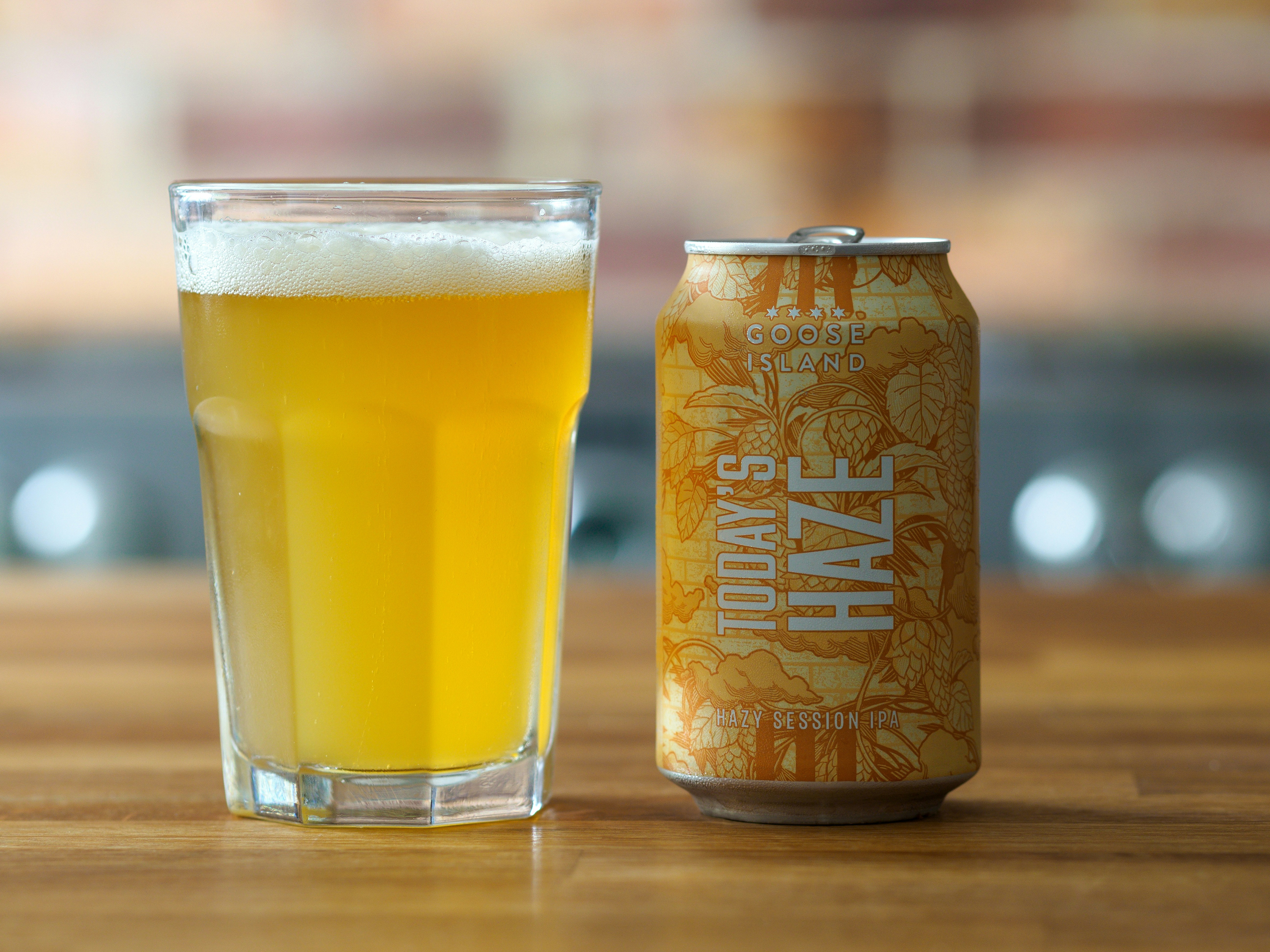 Golden Pint by the Counter: A Can and Fresh Foam atop Wood