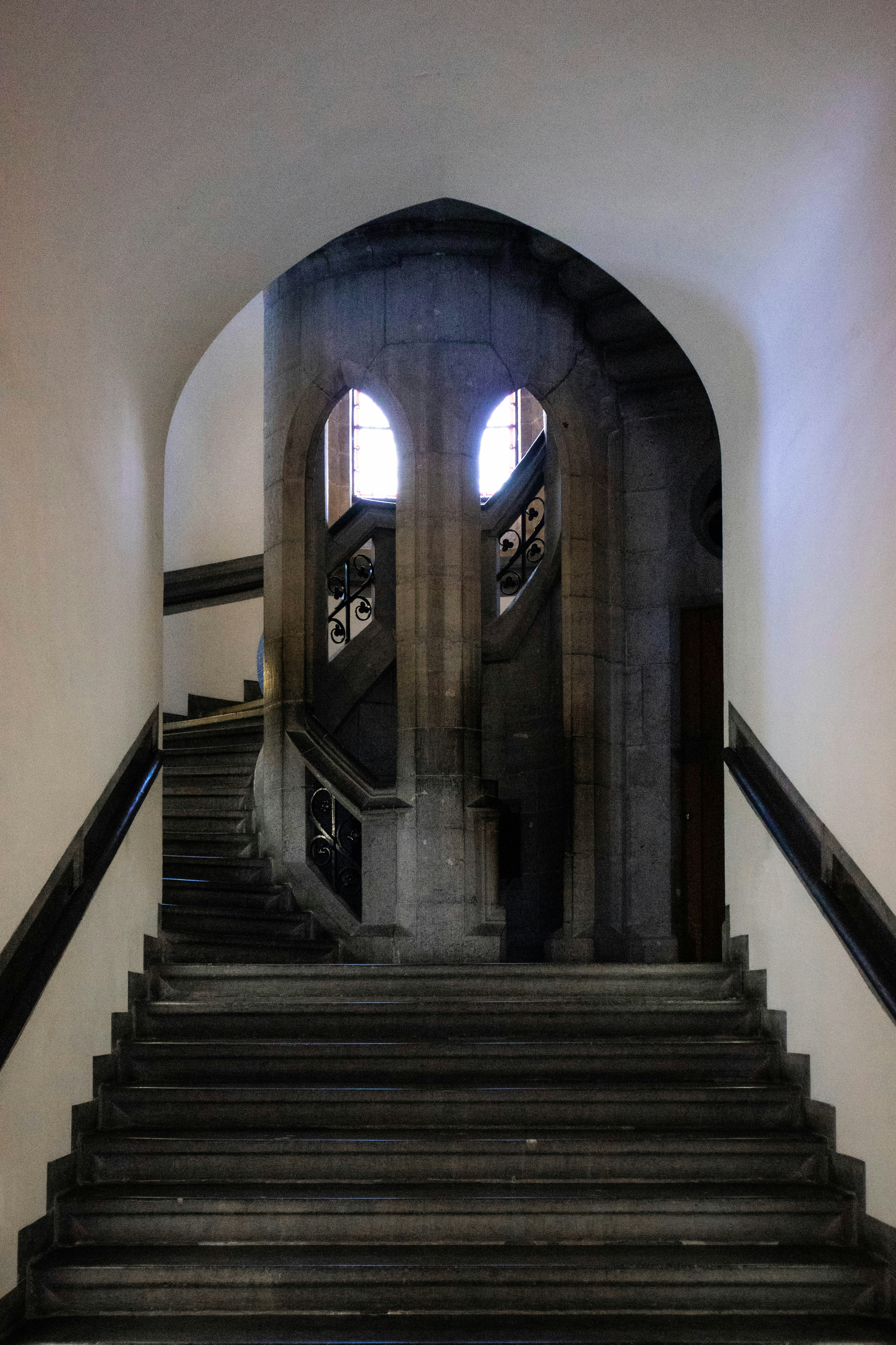 Stone Staircase Through an Archway into a Dim Interior