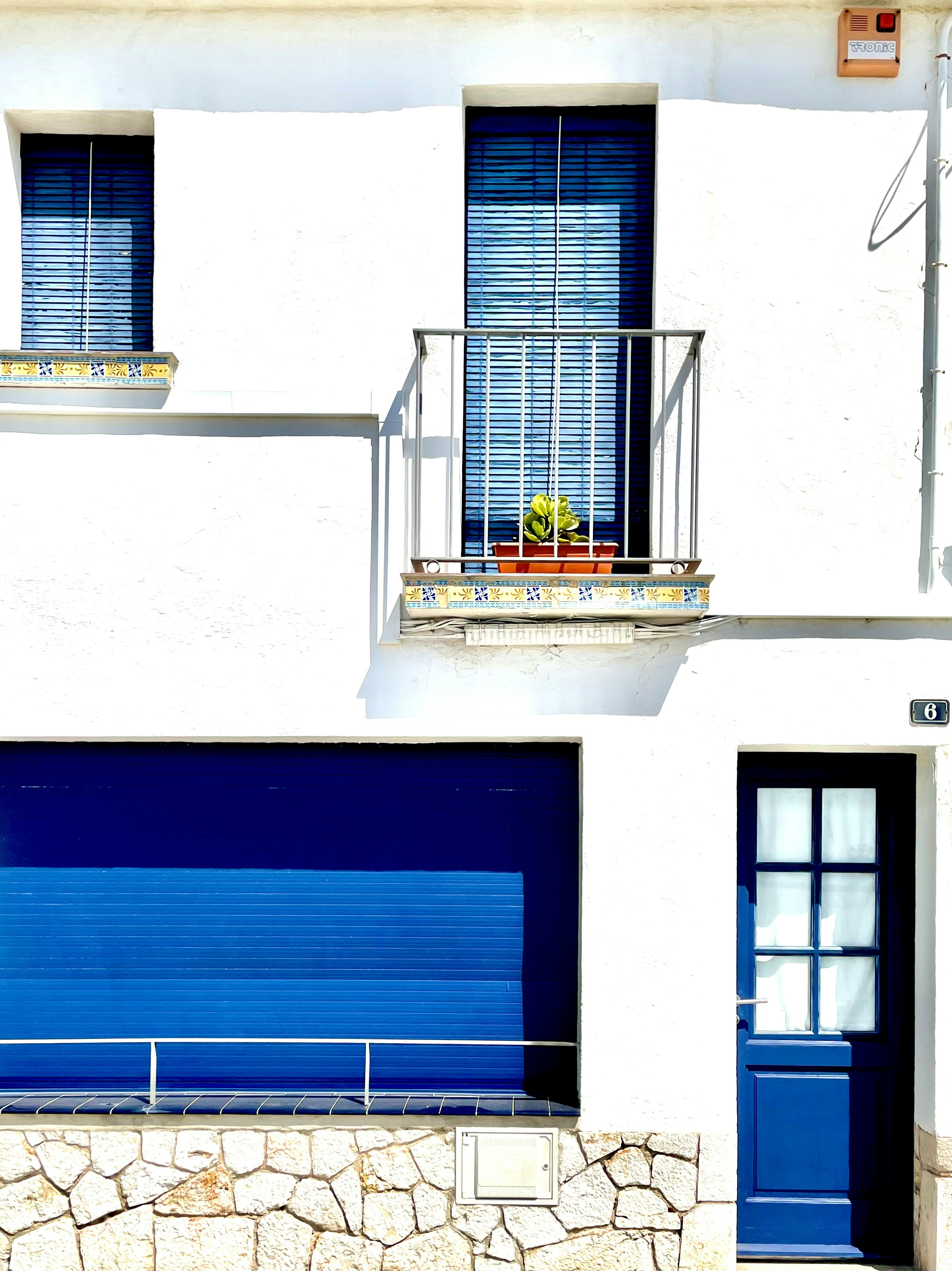Blue Door and Windowed Facade on a Whitewashed Wall