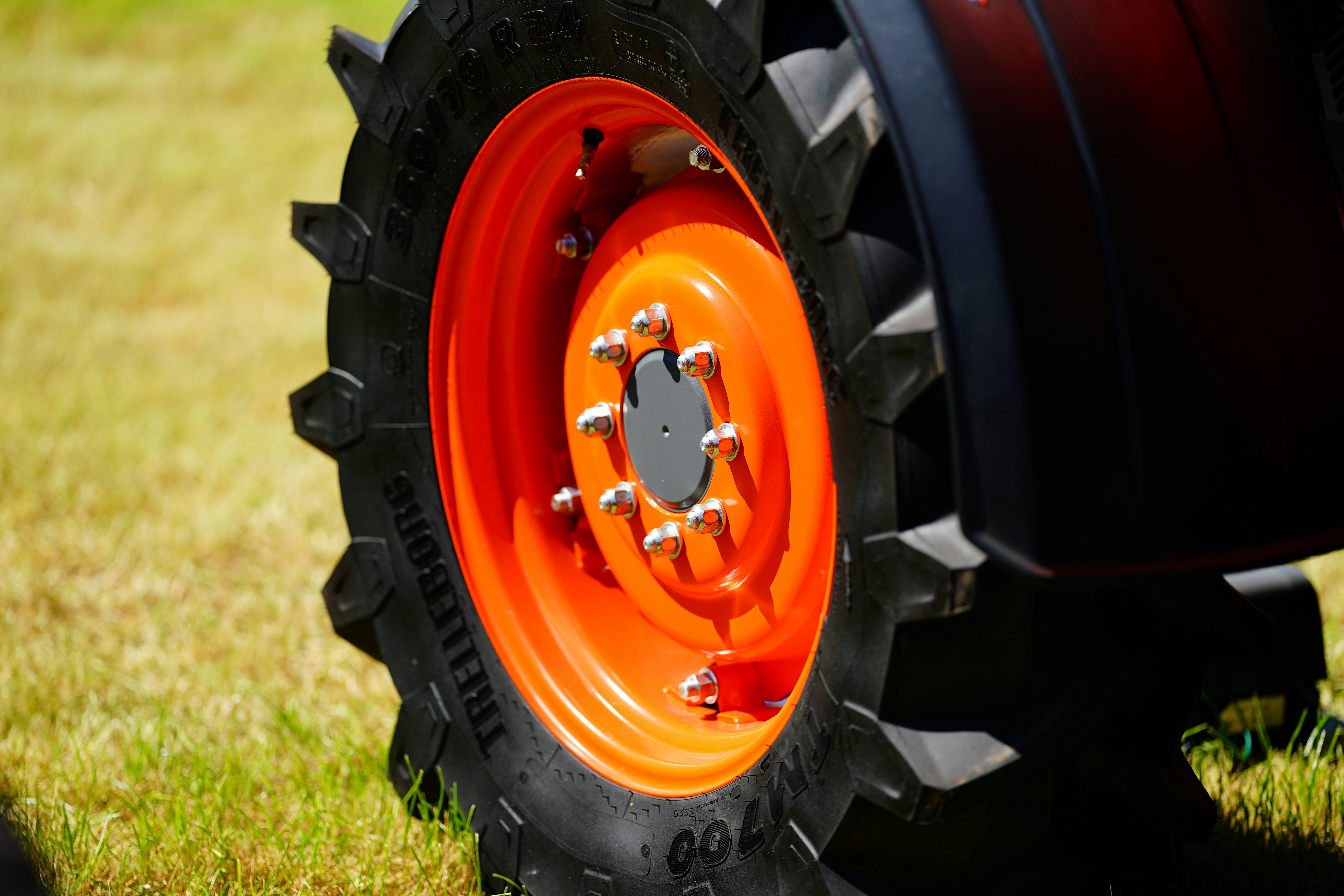 Orange Wheel in Focus: a Tractor Tire at Noon