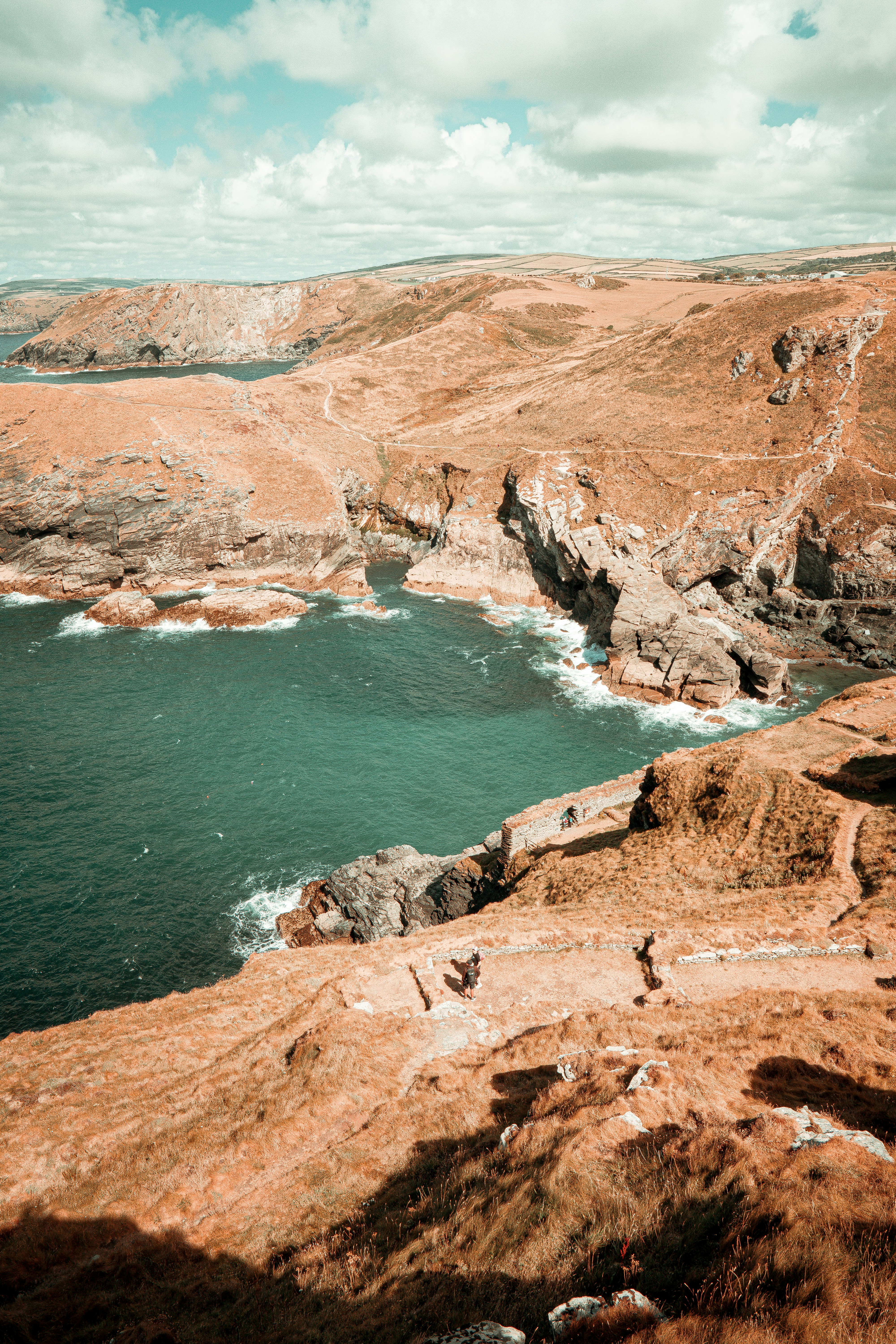 Terracotta Cliffs Framing a Turquoise Sea Inlet