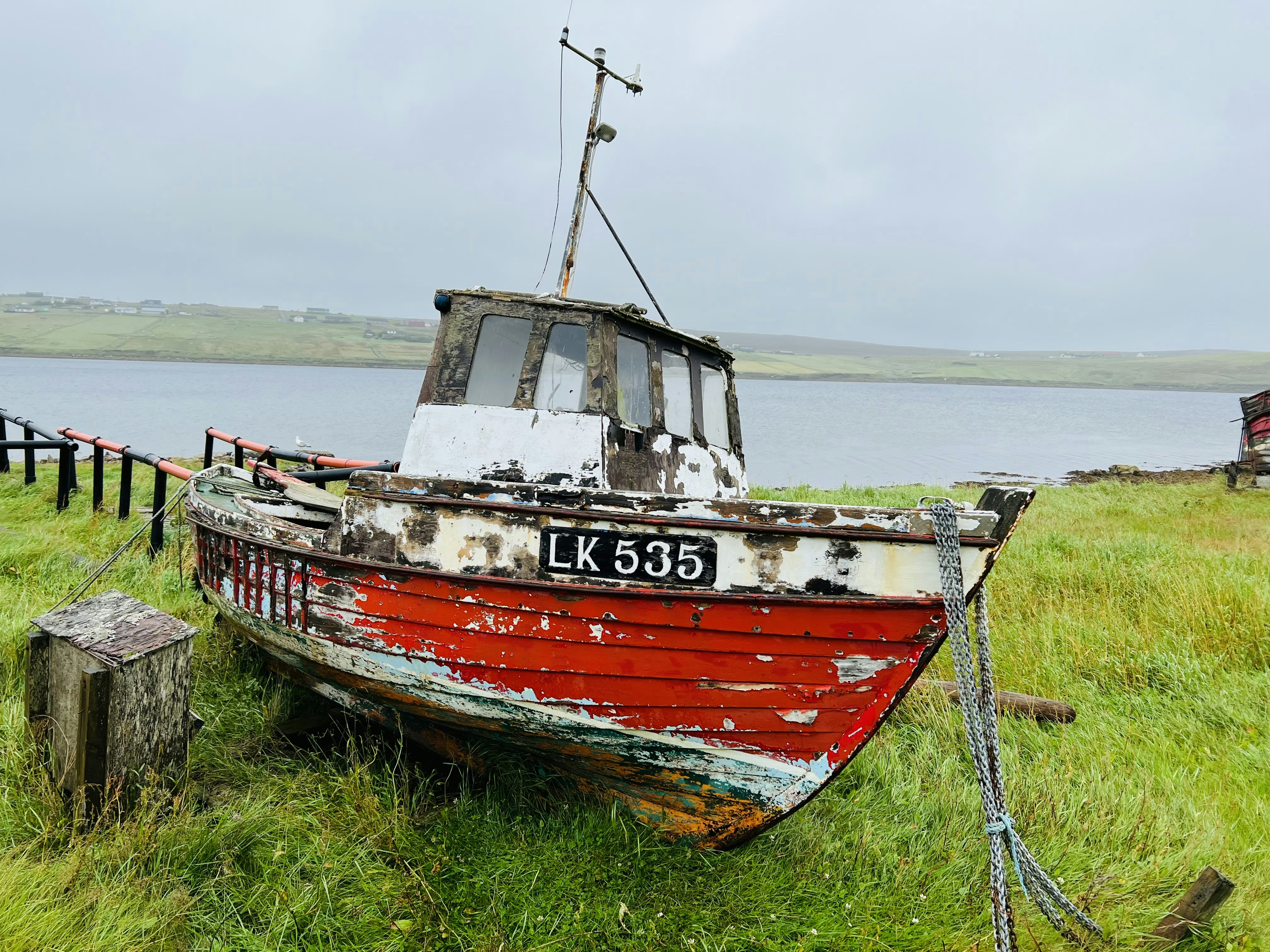 Rust, Grass and Salt: A Weathered Boat at the Estuary's Edge