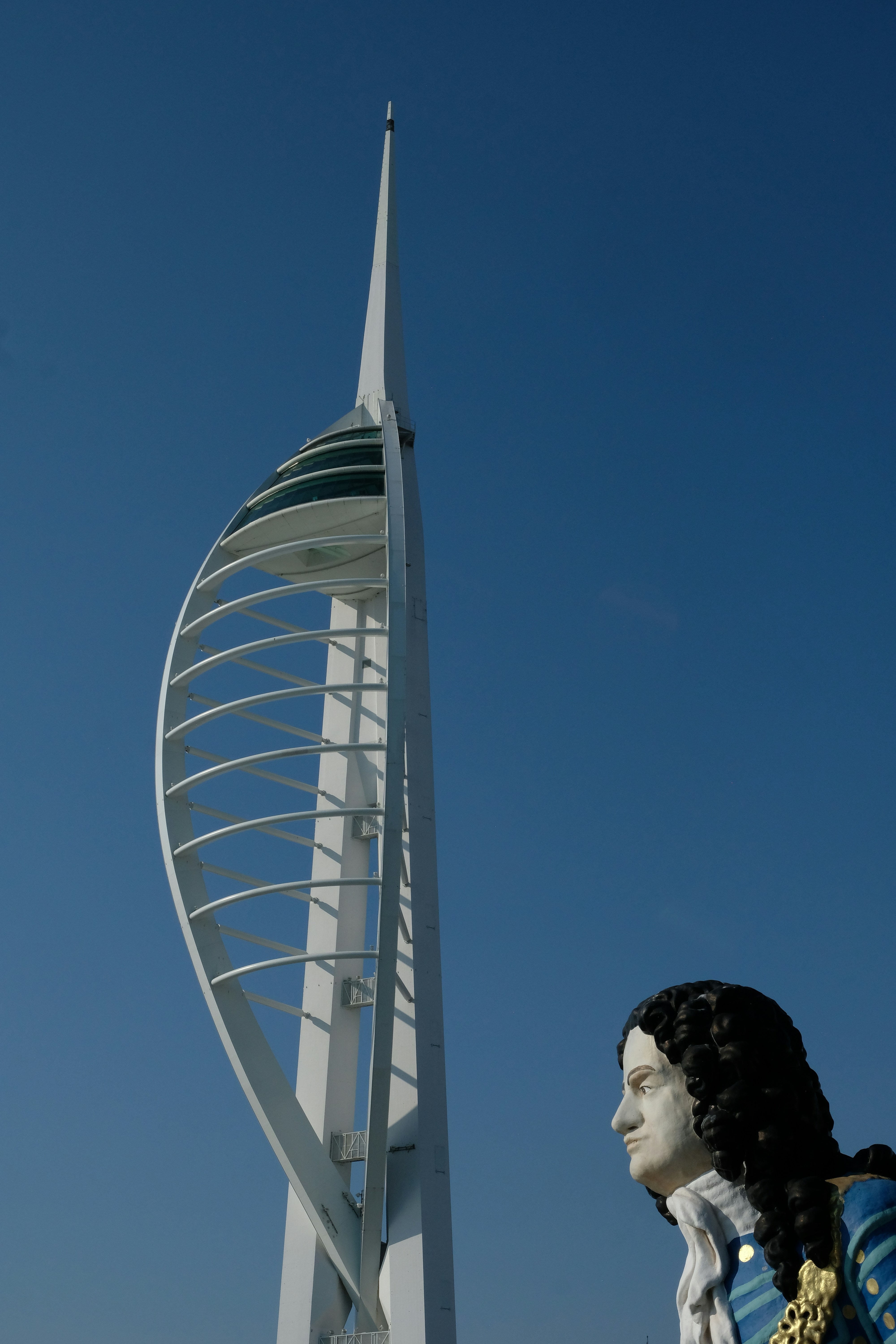 Spire Against the Sky: A Sail-Like Tower and a Marble Bust