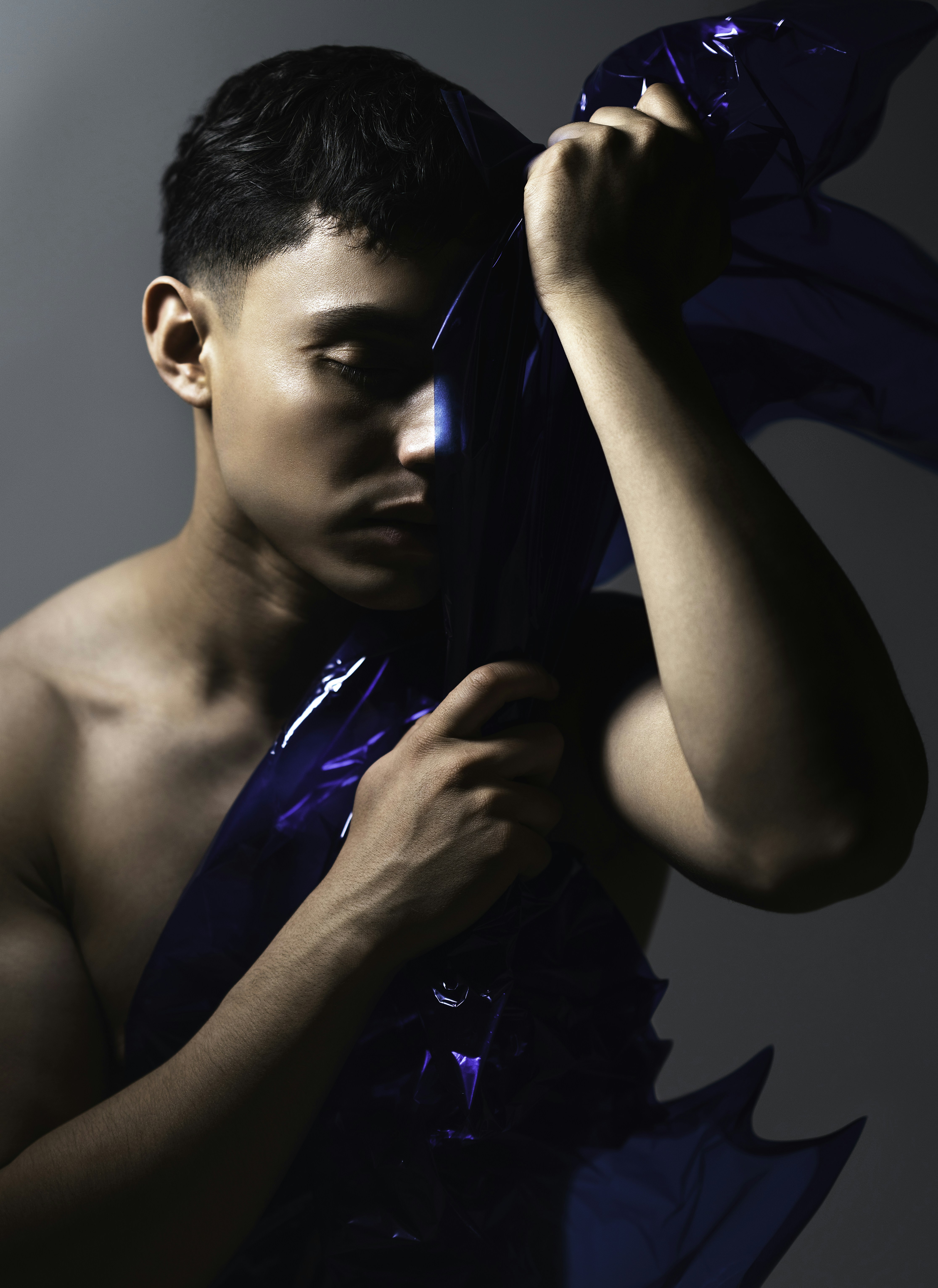 Veiled Intensity: A Portrait Wrapped in Violet Plastic