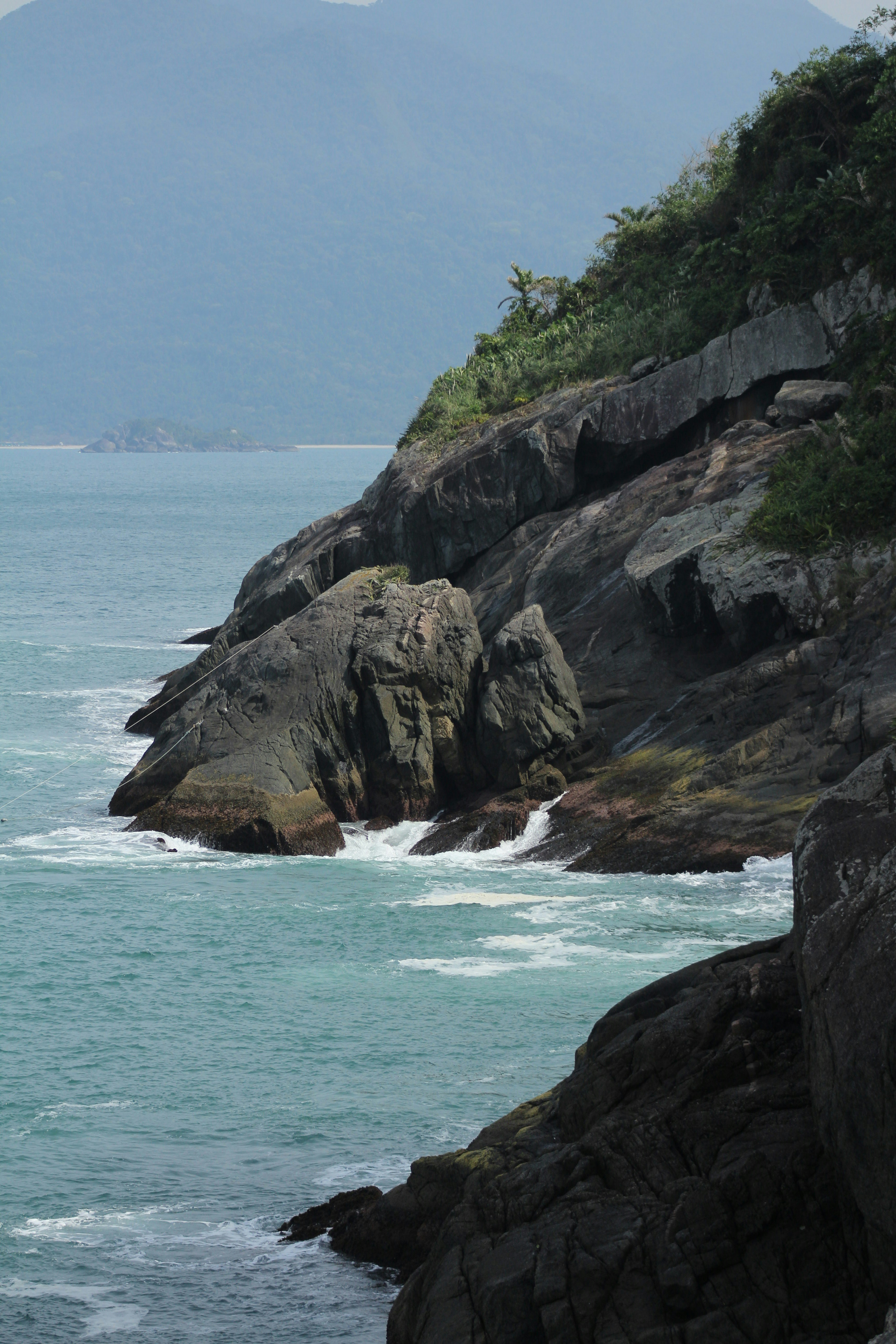 Un acantilado rocoso con un cuerpo de agua debajo foto – Imagen de ...