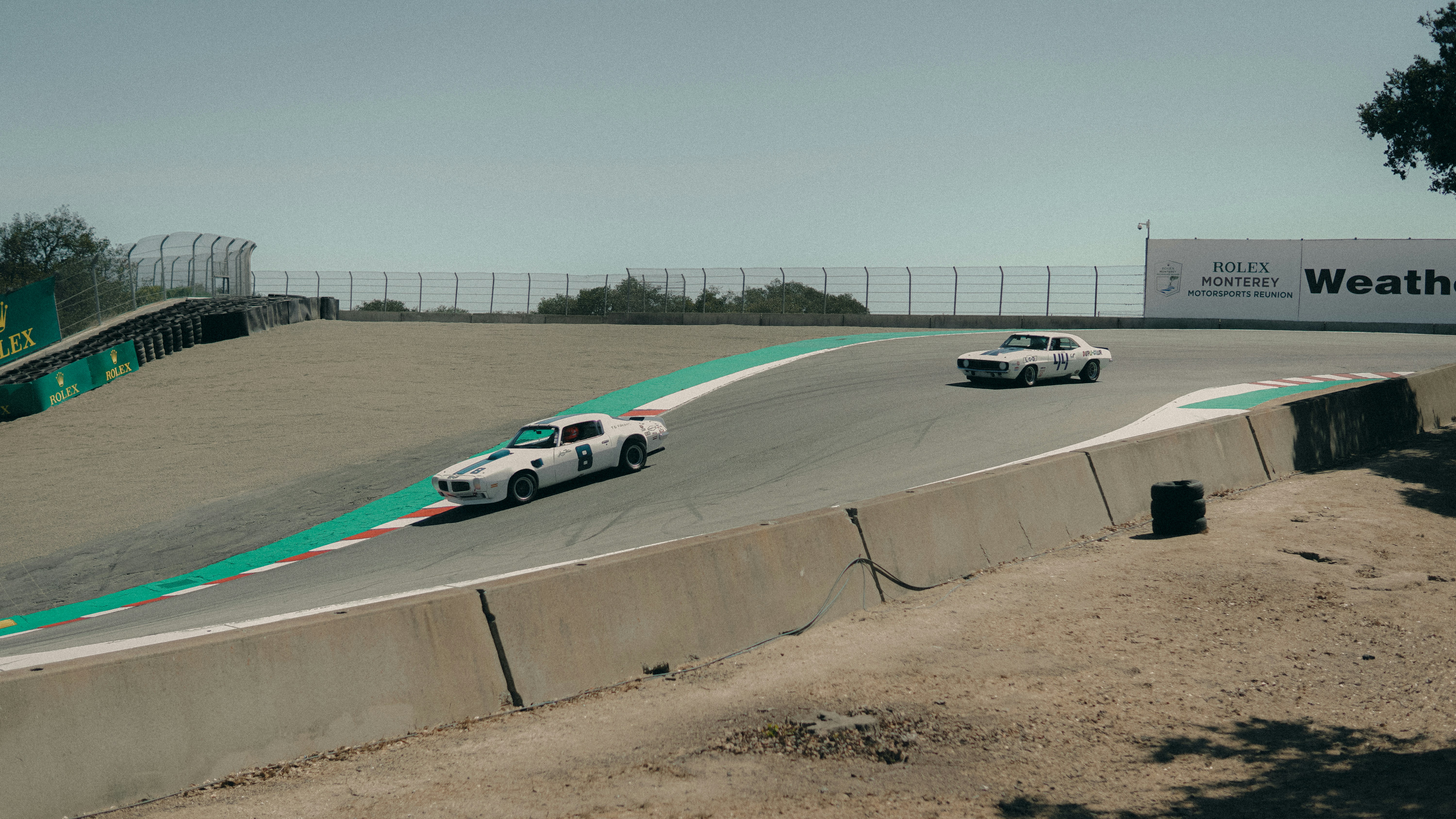 A couple of cars driving on a race track photo – Free Car Image on Unsplash