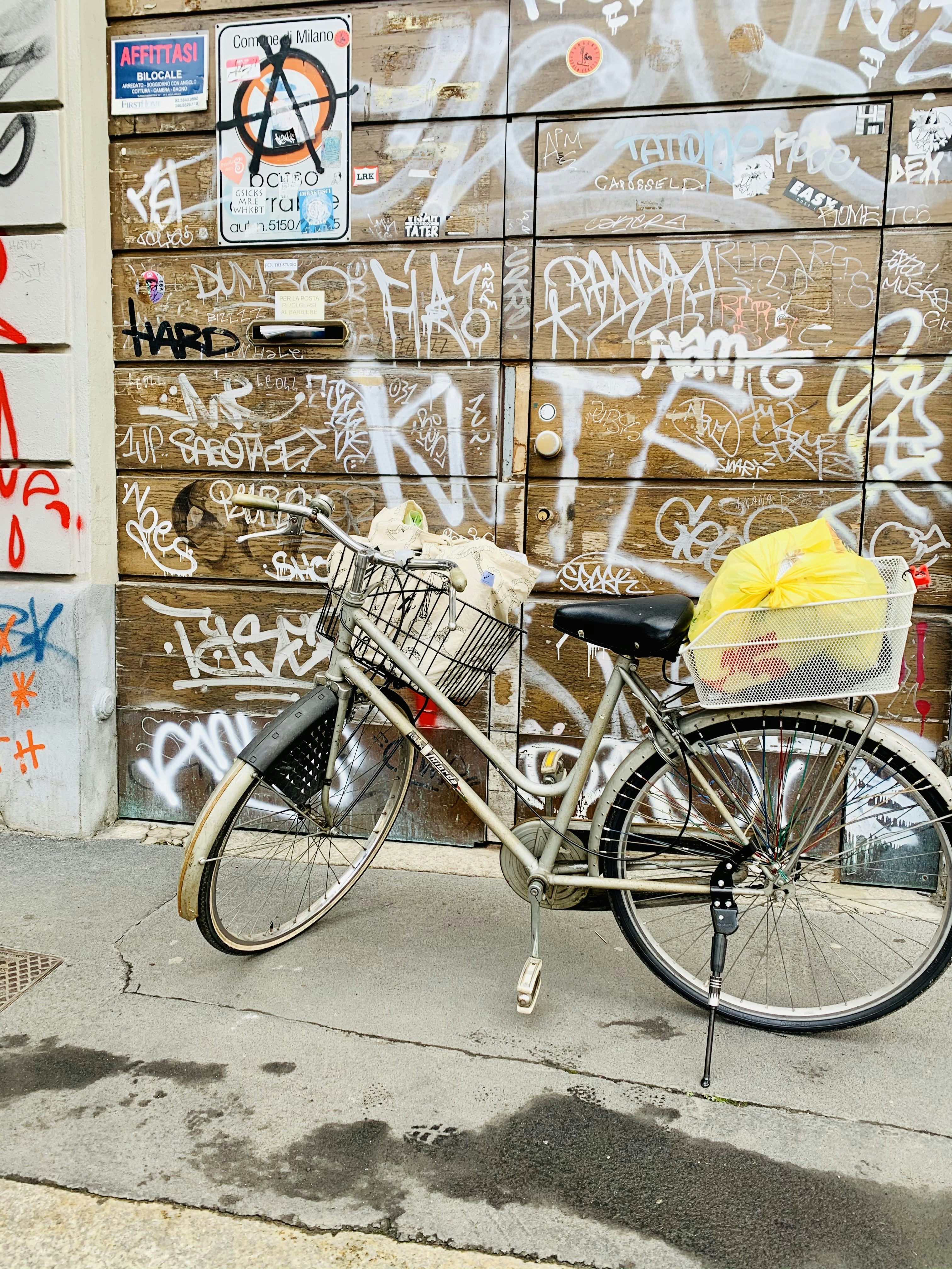 Bike with a Neon Yellow Load Against a Graffiti Wall