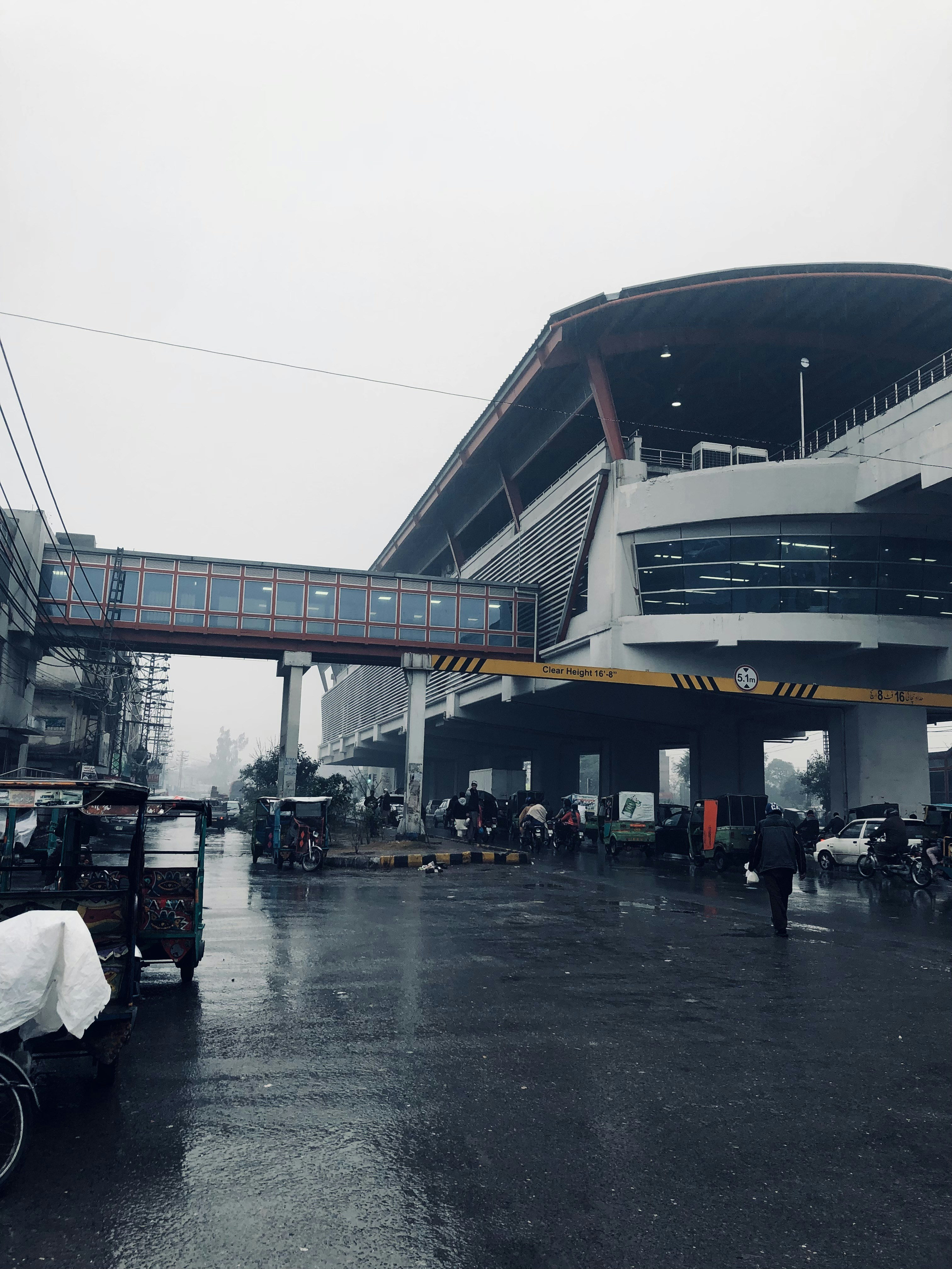 Skybridge Echoes: A Rain-Washed Terminal Forecourt