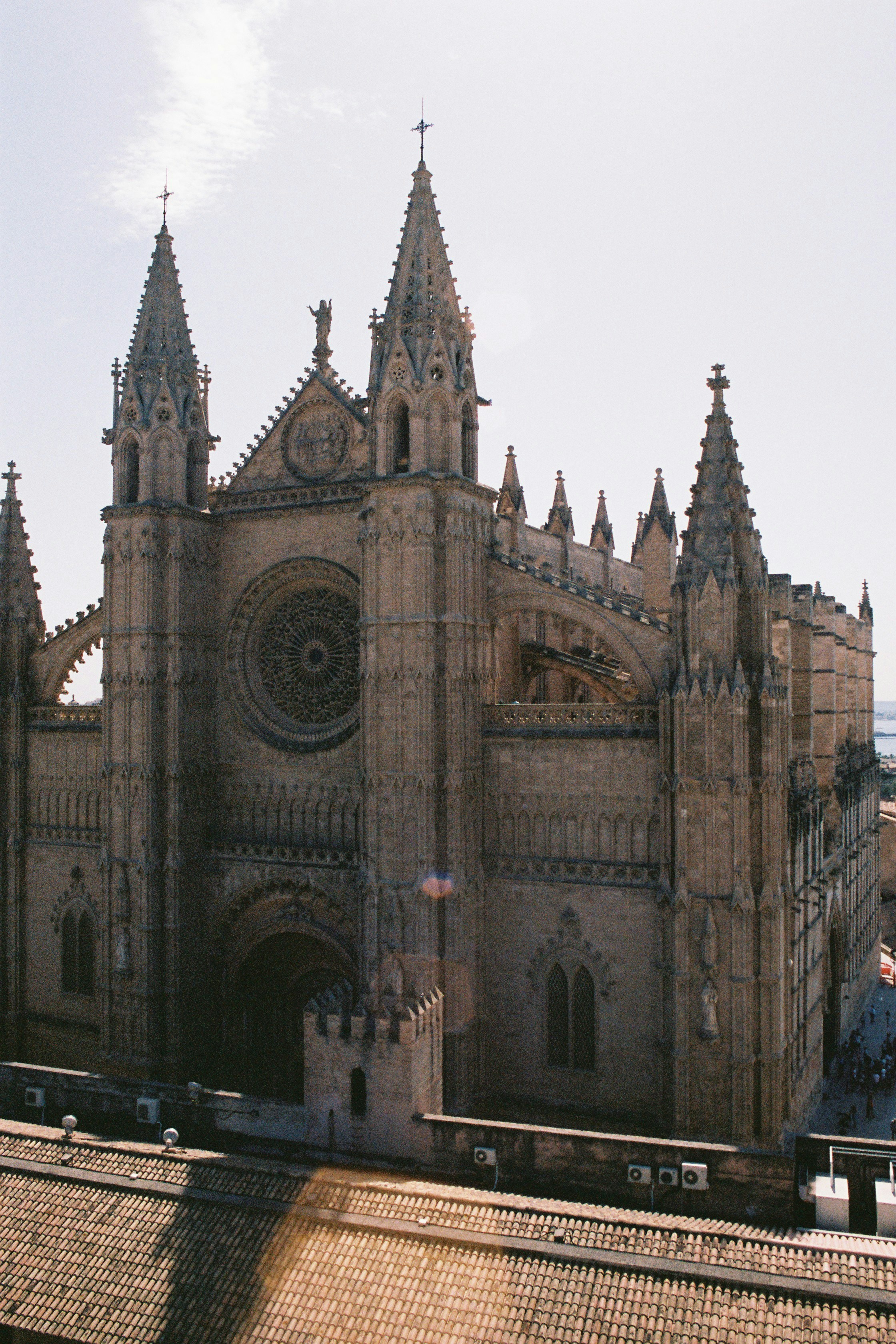 Intricate Gothic cathedral showcasing towering spires and detailed stonework against a clear sky.