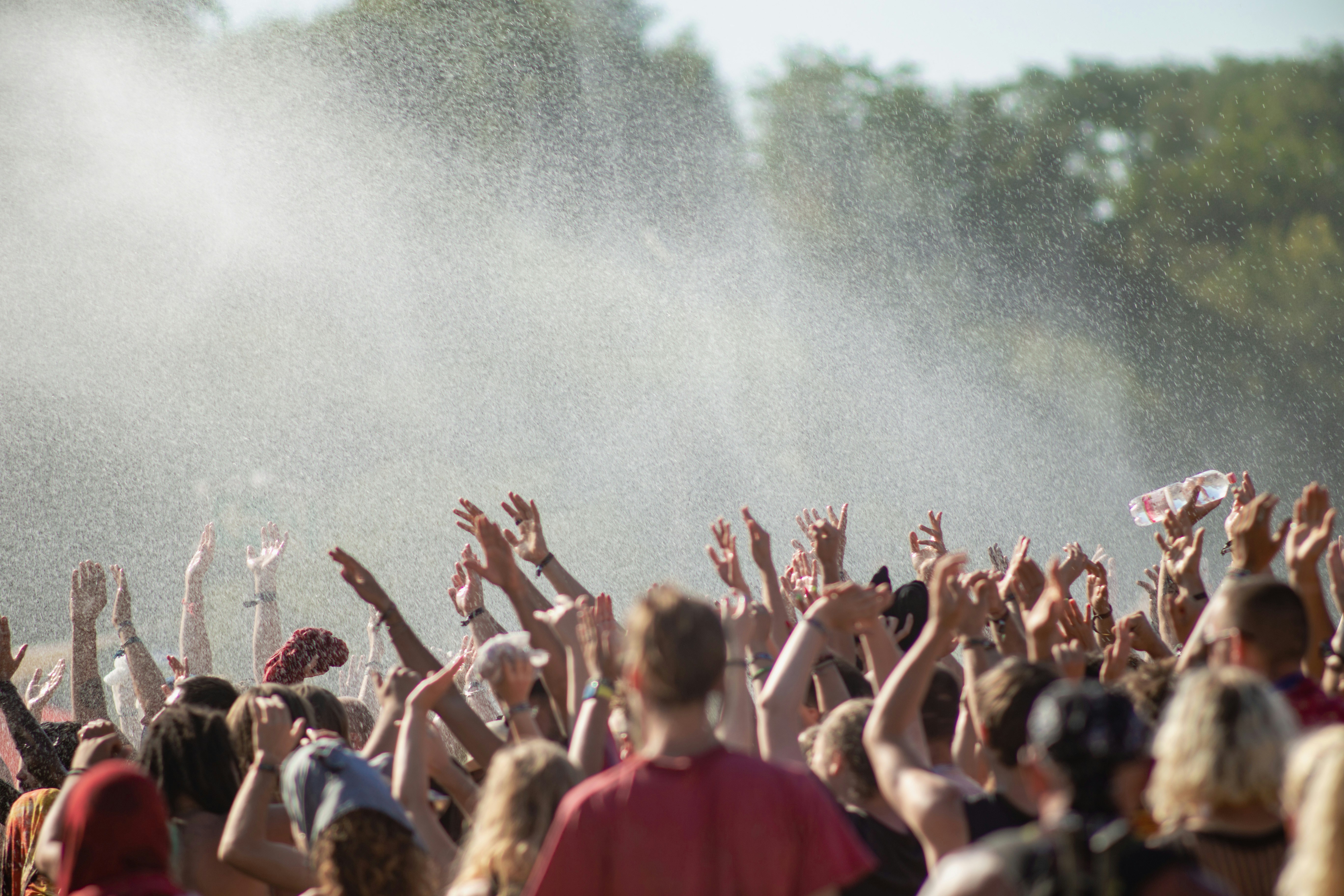 A crowd of people with their hands up in the air photo – Free Grey ...