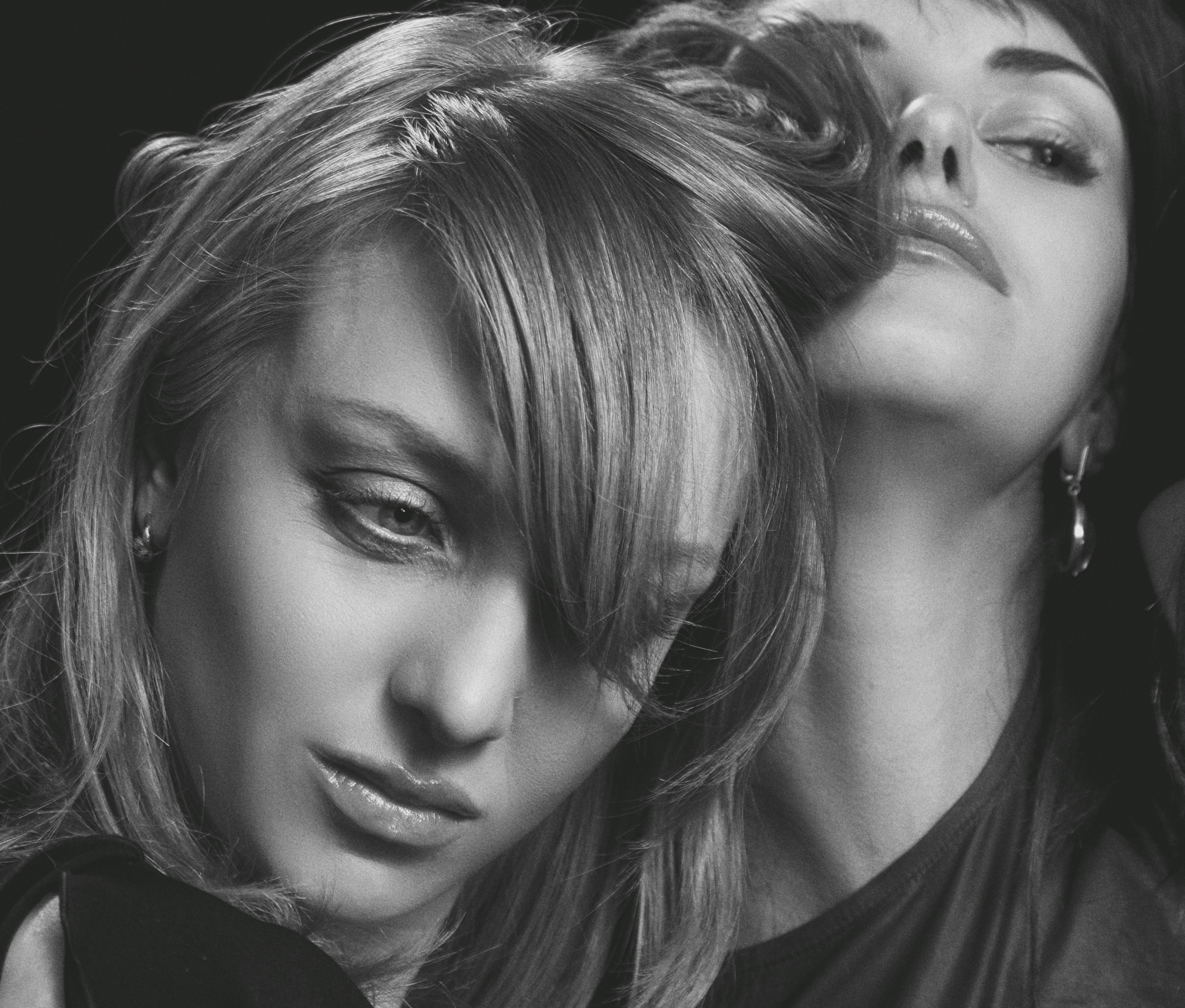 A woman kissing another woman on the cheek photo – Free Grey Image on ...